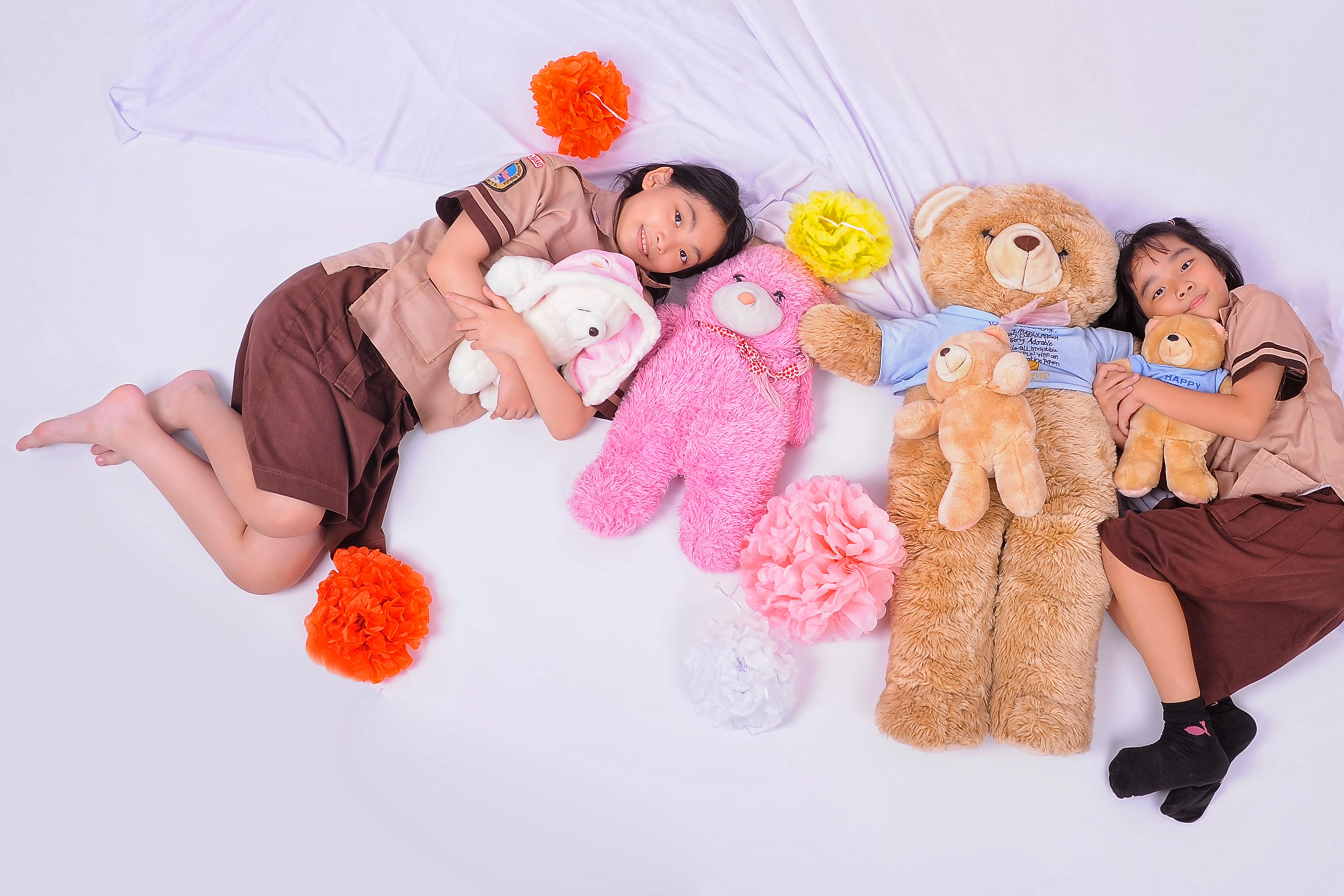 Girls in Uniform Hugging Stuffed Toys · Free Stock Photo