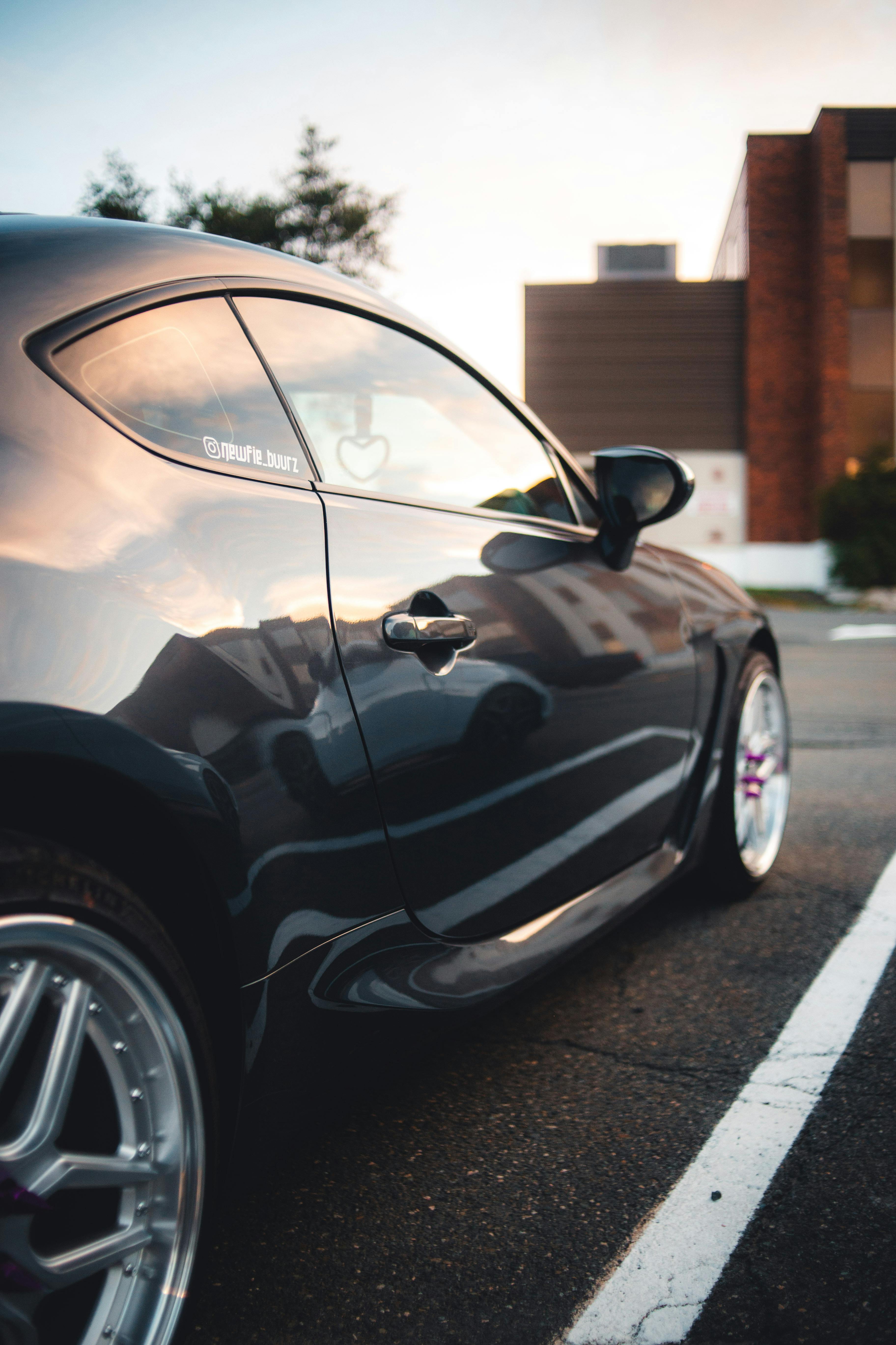 Black Car with Silver Wheels Parked in a Parking Lot · Free Stock Photo