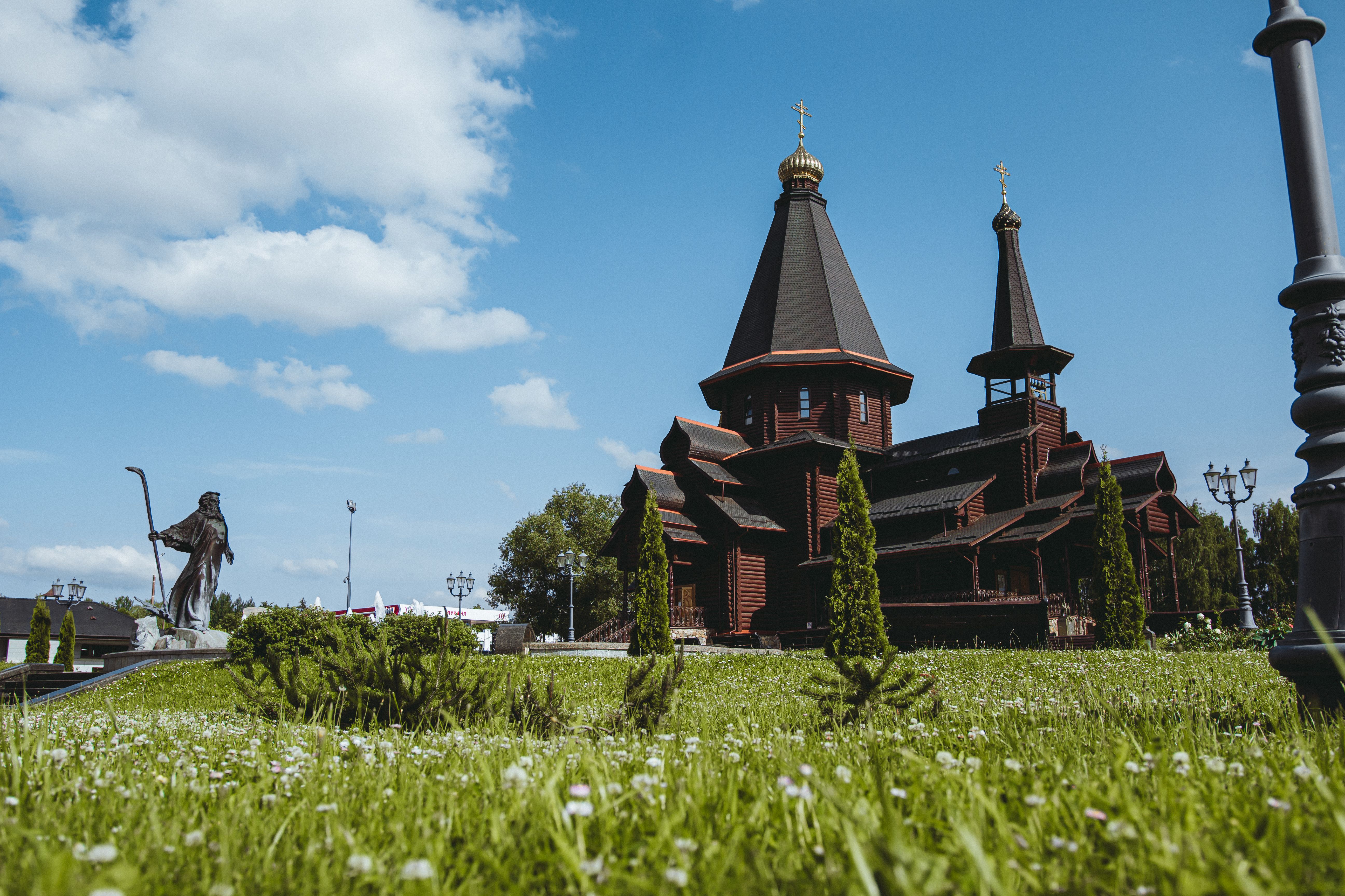 Brown and Black Temple Surrounded by Green Grass Field Under Blue Sky ...