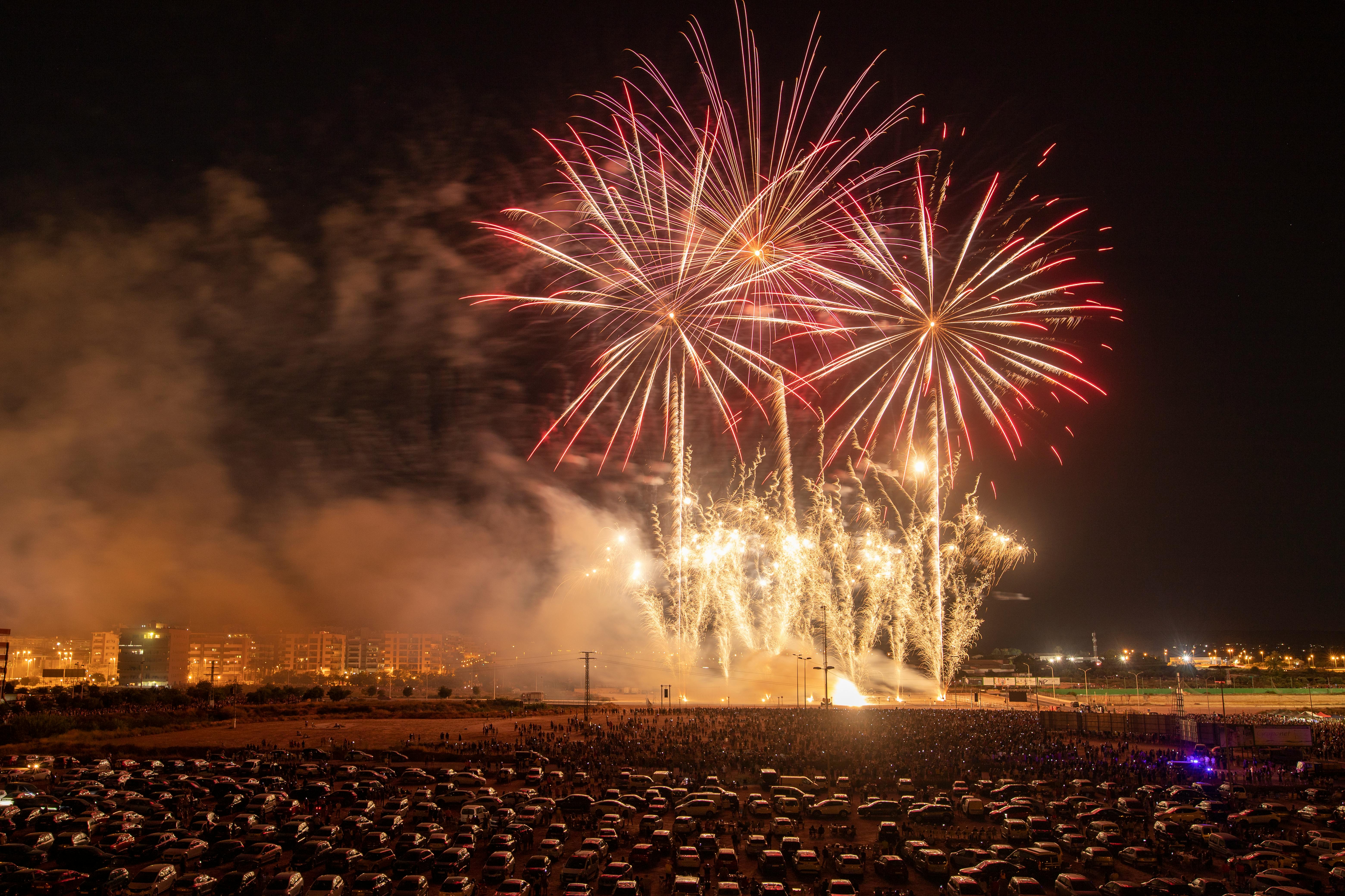 Explosion of Fireworks and Car Park Full of Cars at Night · Free Stock ...