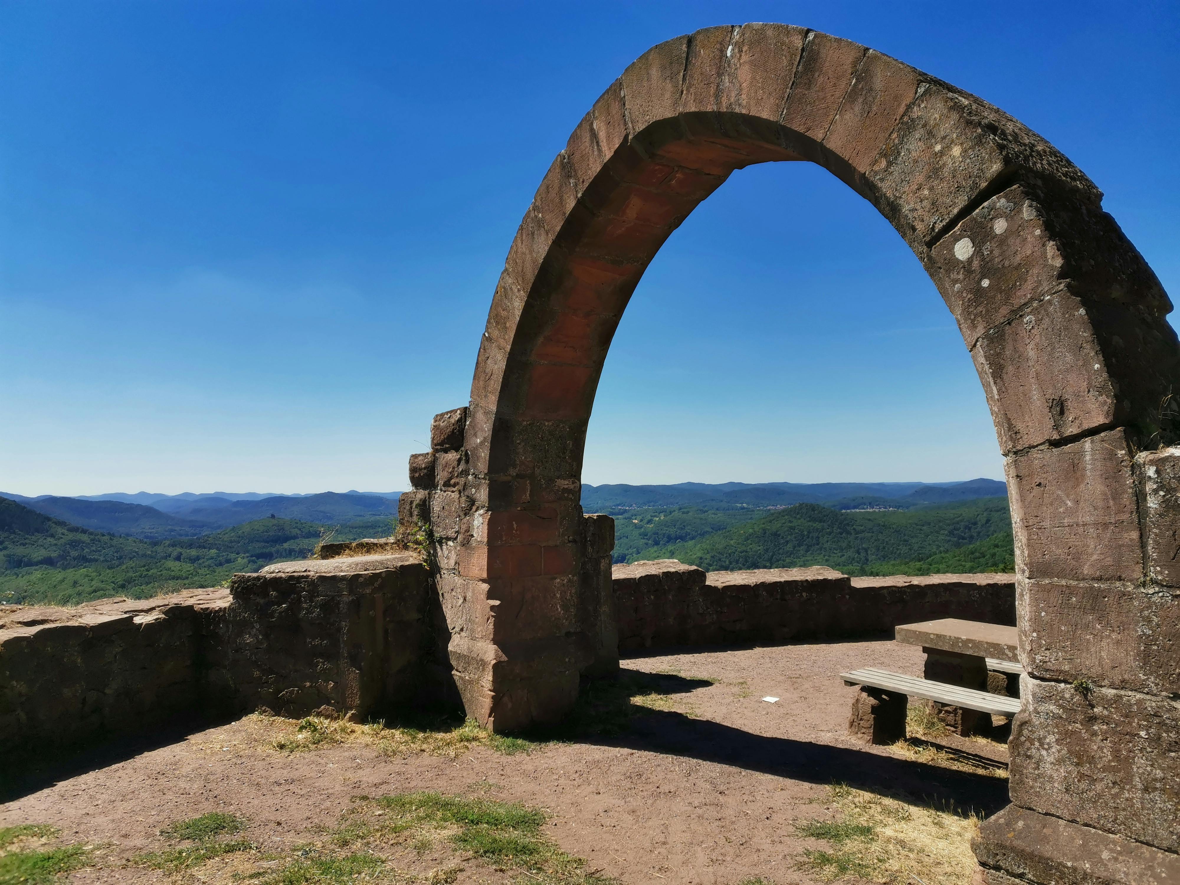 Clear Blue Sky over a Stone Arch · Free Stock Photo