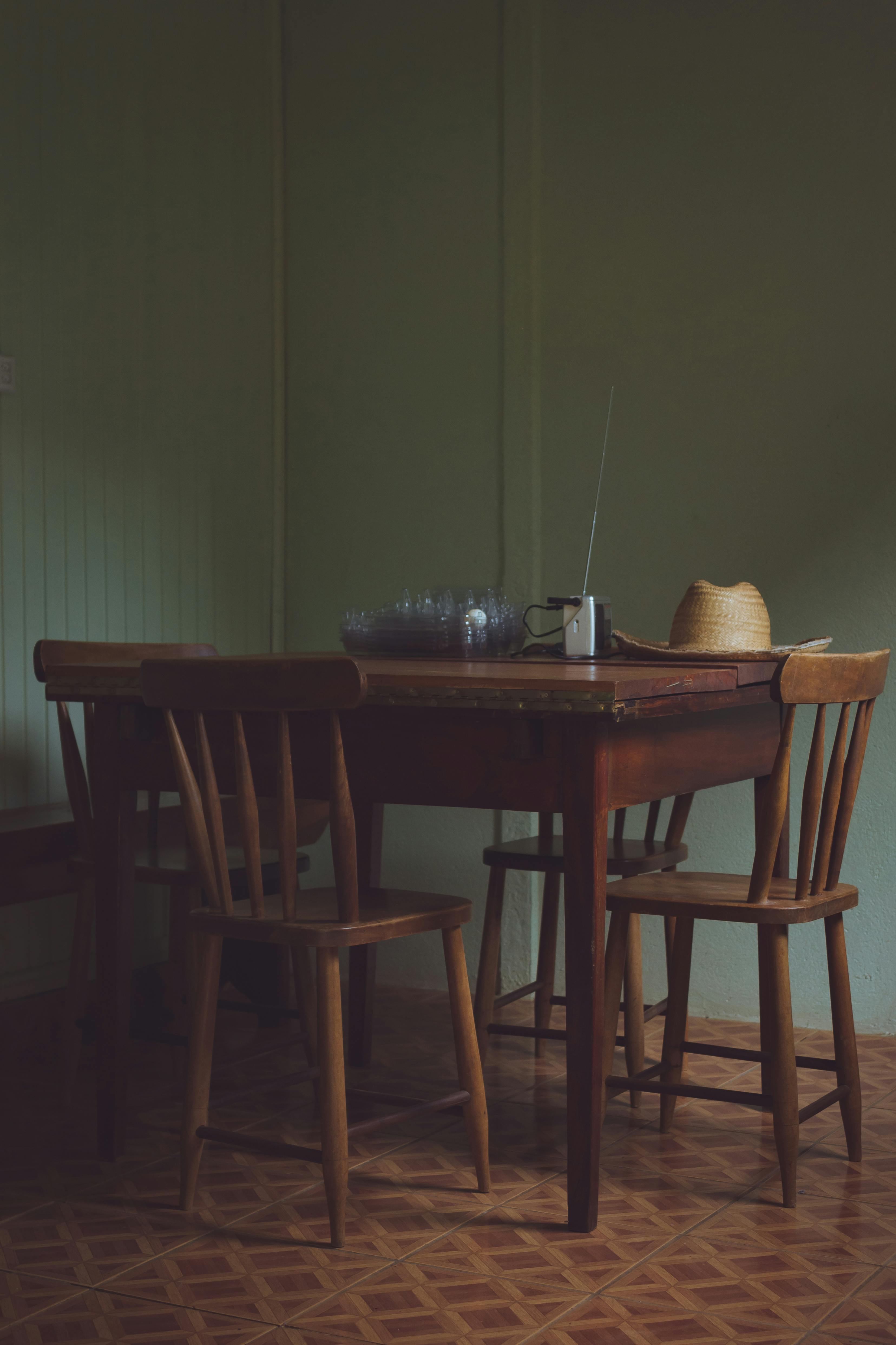 A Radio and Straw Hat Placed on a Brown Wooden Table With Brown Wooden ...