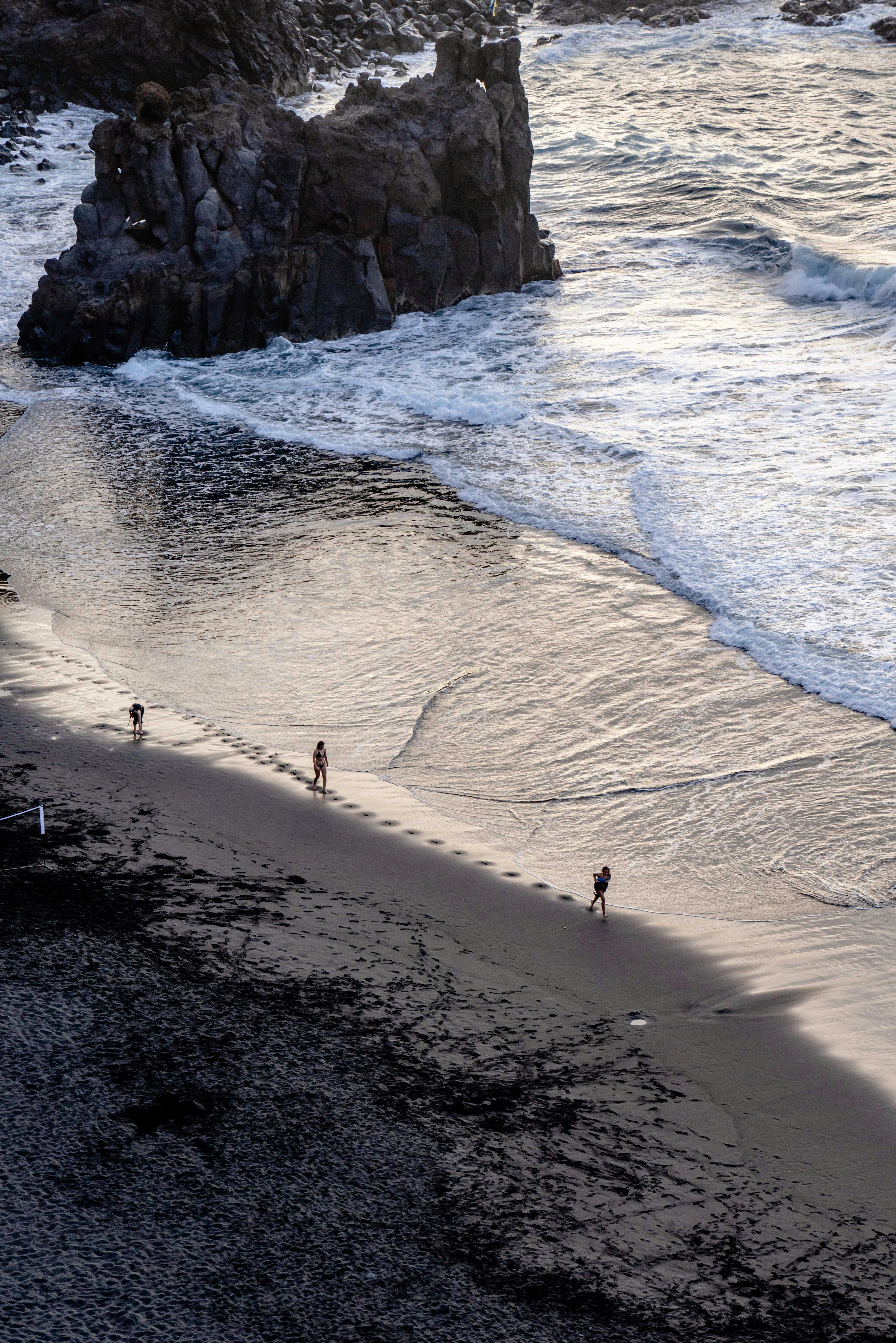 Photo of People Walking at a Beach · Free Stock Photo