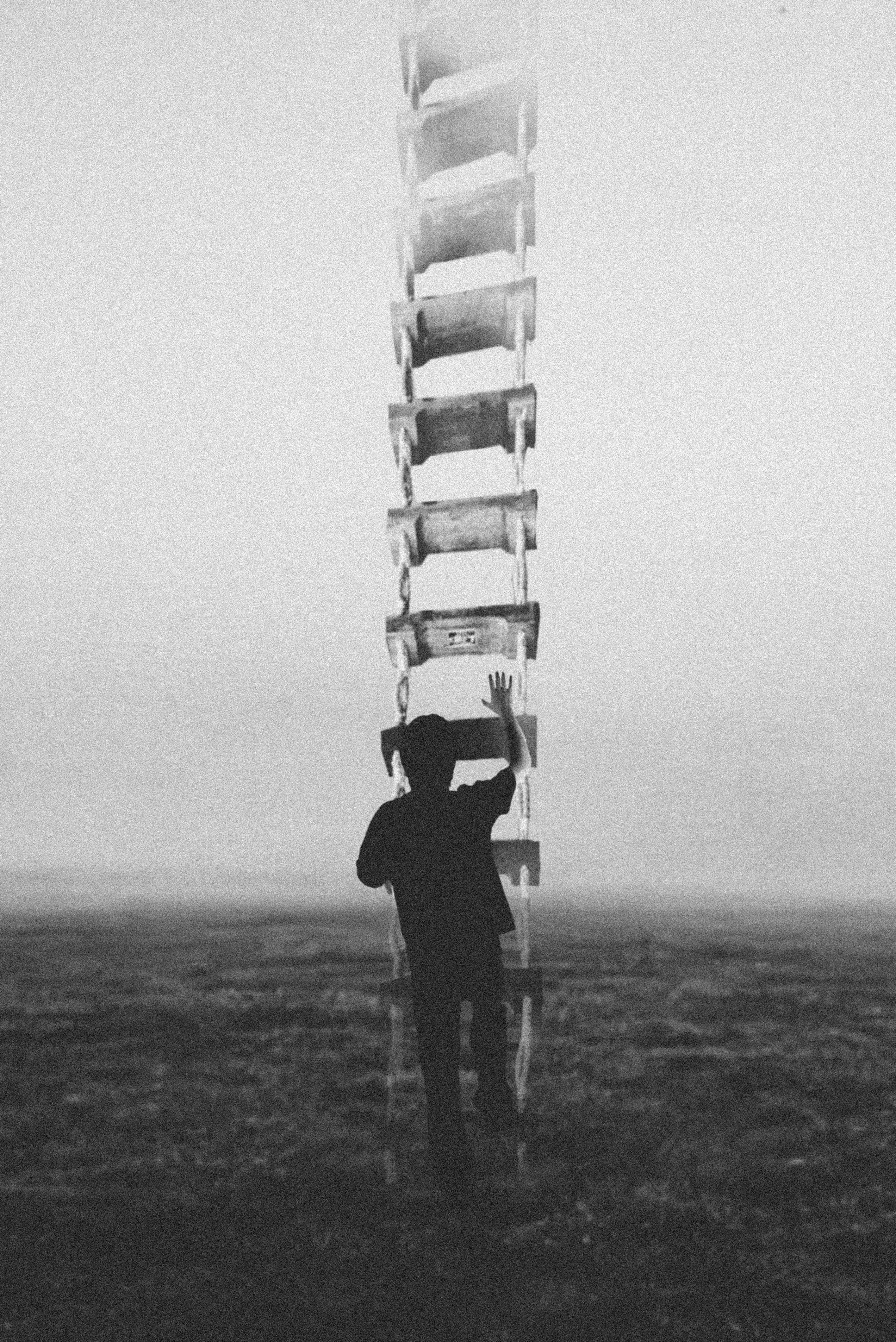 Faceless melancholic person standing in darkness with hand in pocket ...