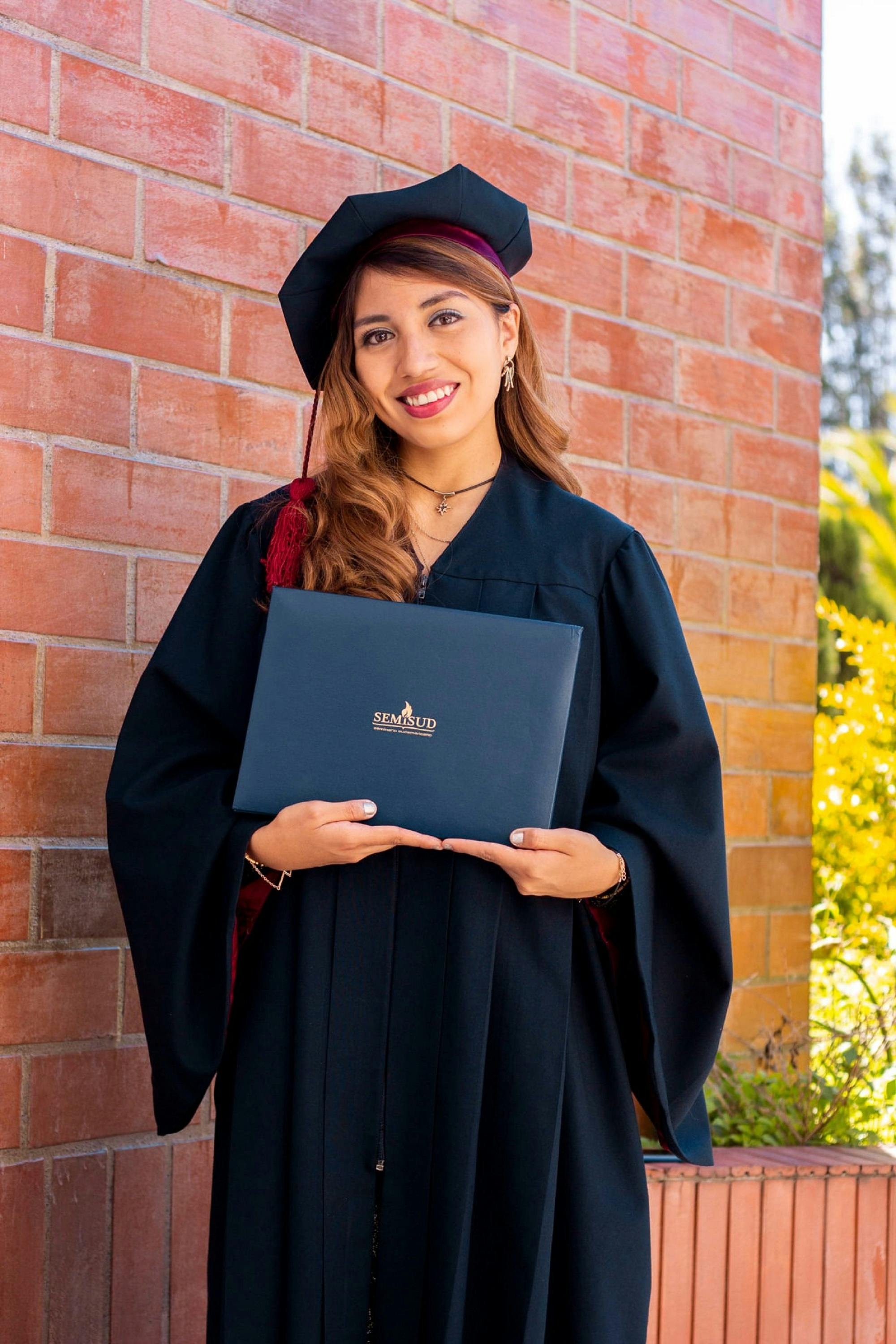 A Woman in Graduation Gown Holding Diploma · Free Stock Photo