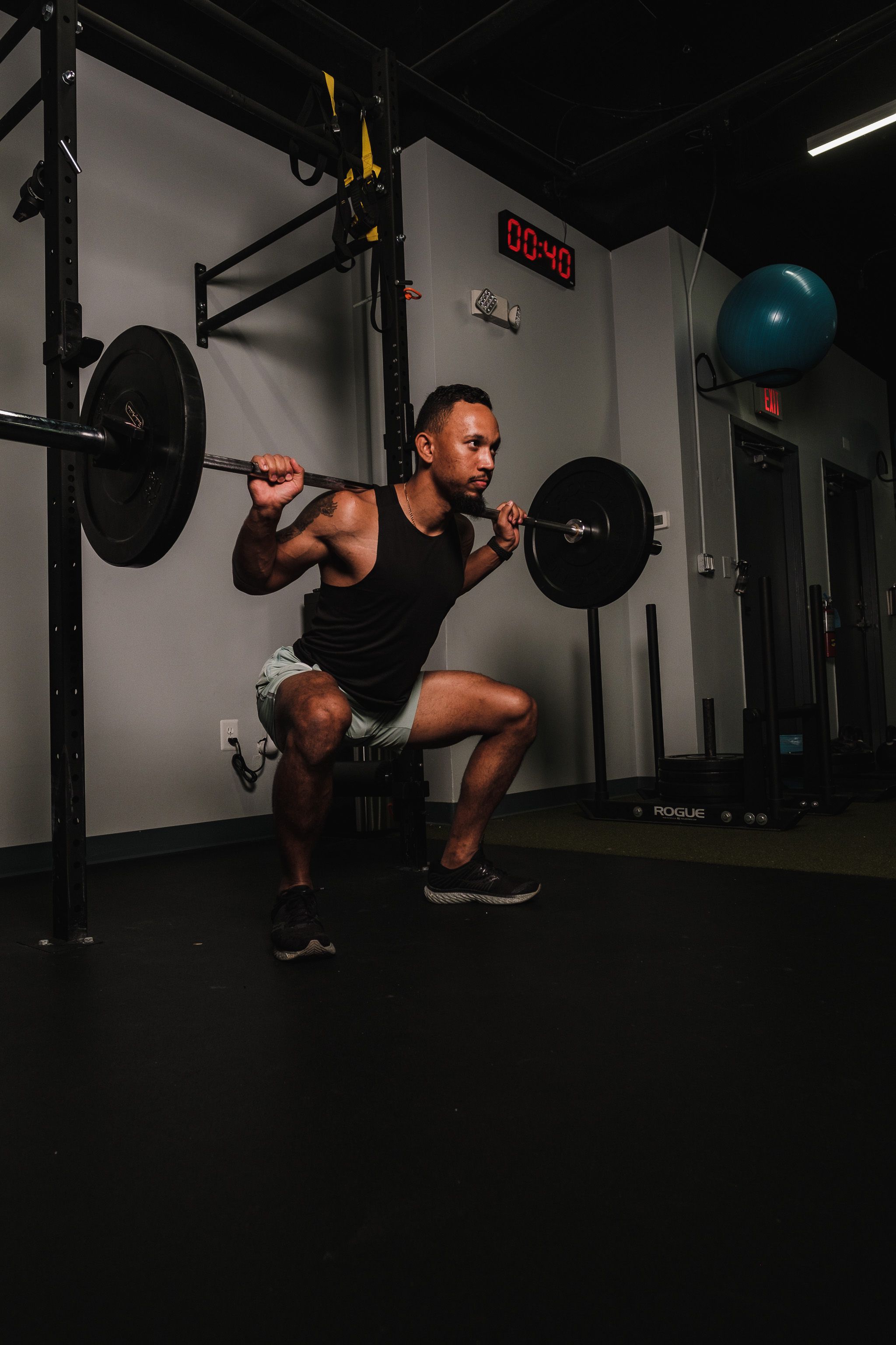 A Man in a Tank Top Working Out in a Gym · Free Stock Photo