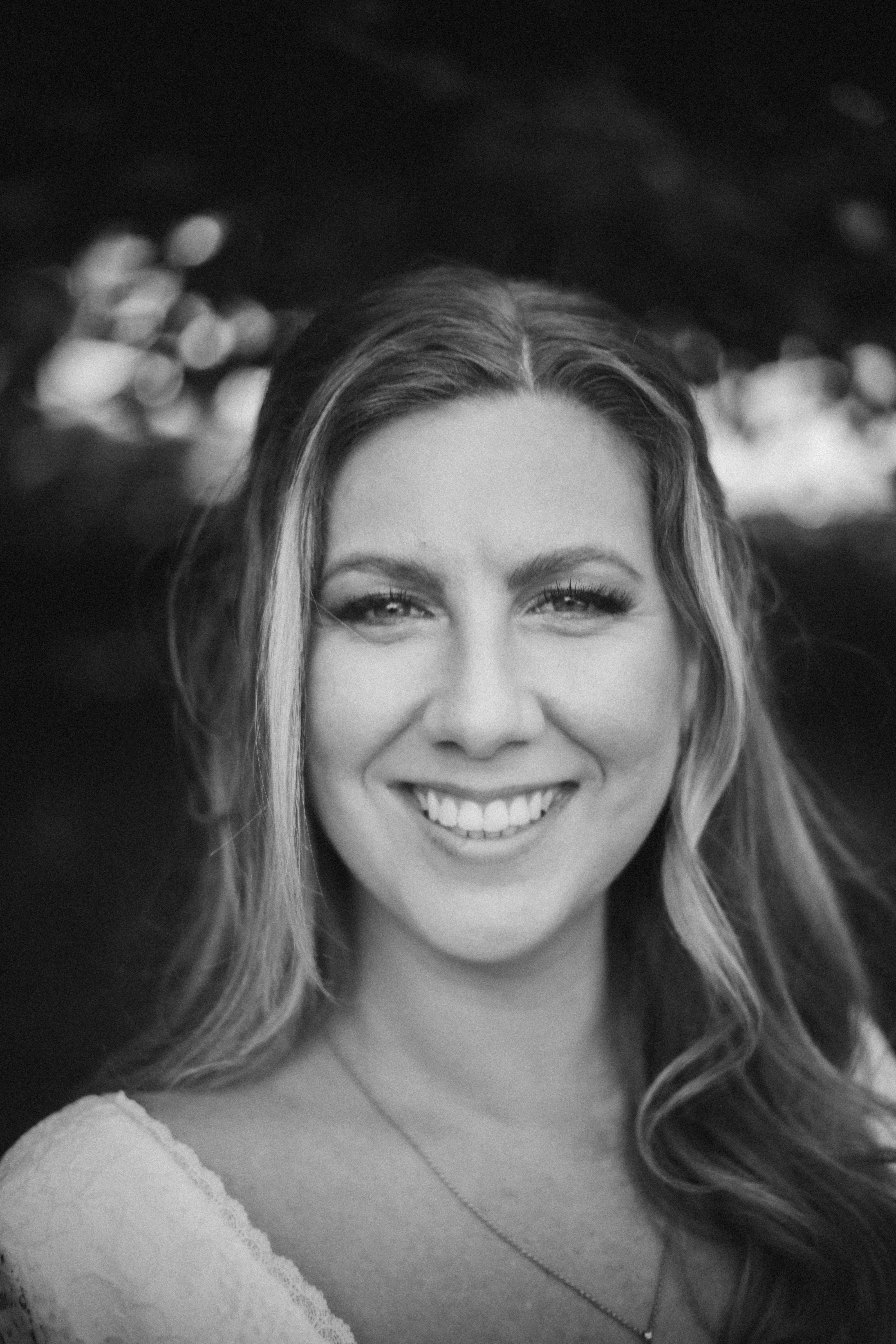 Grayscale Portrait of a Woman Smiling · Free Stock Photo