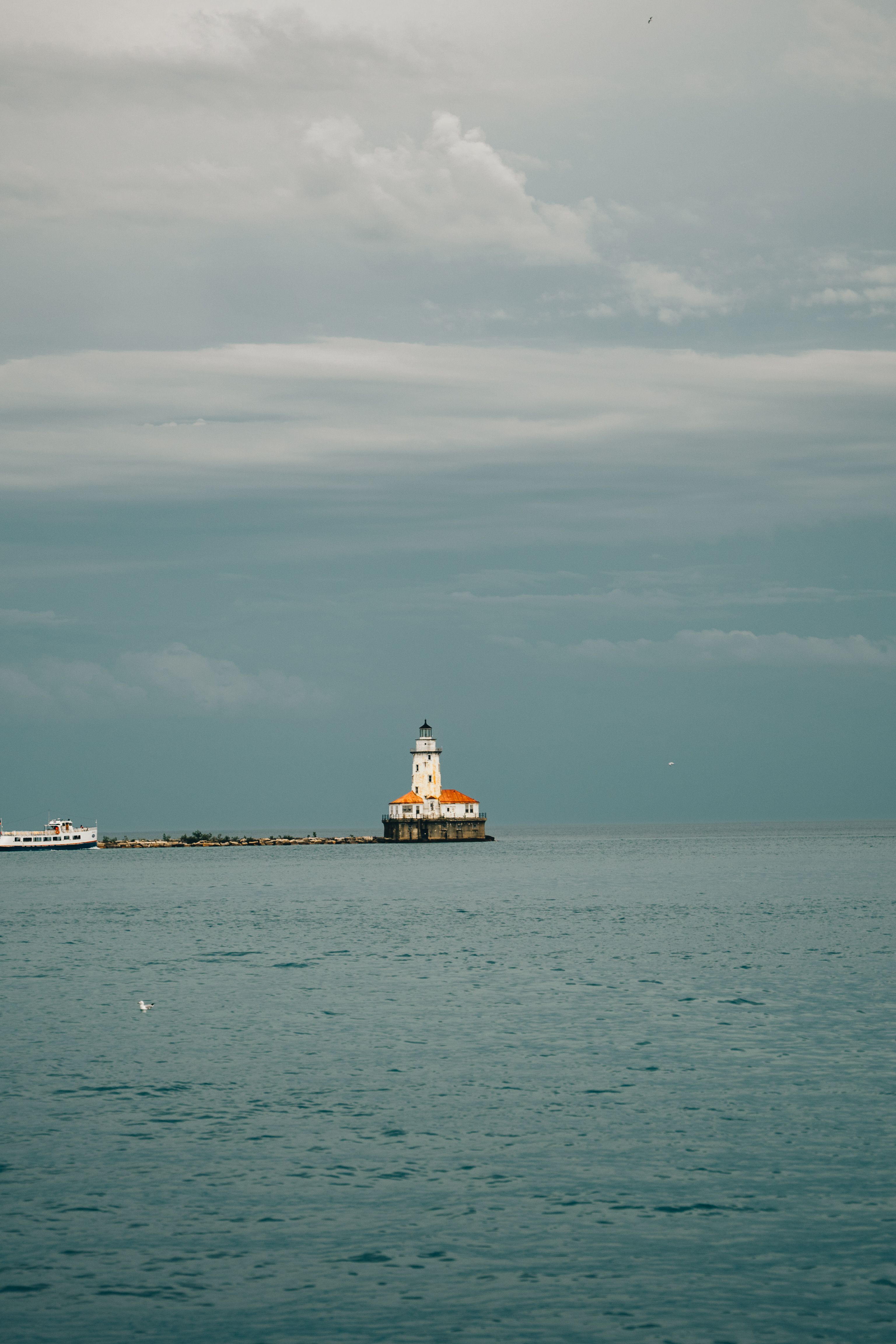 Photo of a Coast with a Lighthouse · Free Stock Photo