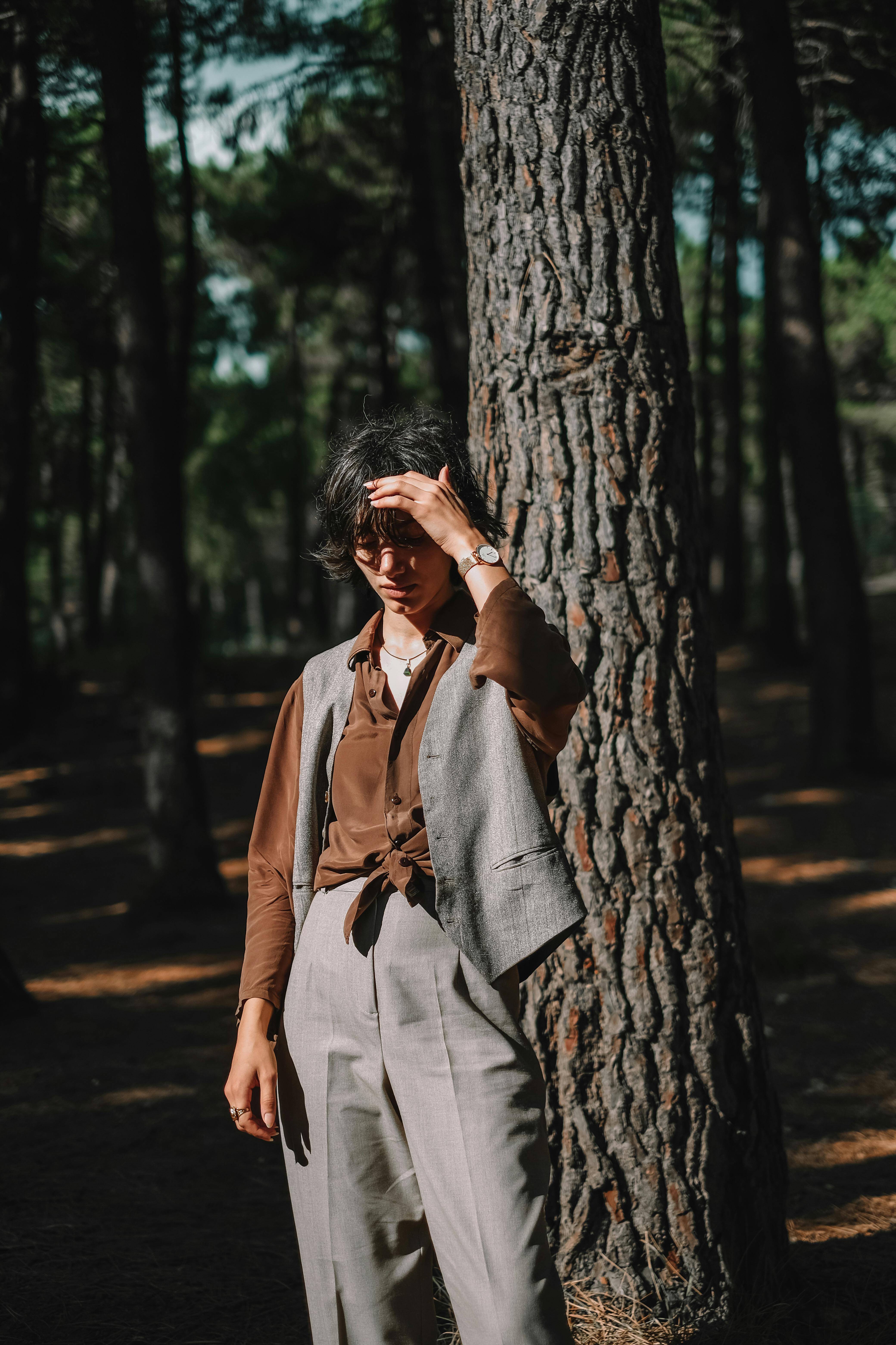 Woman Standing Beside Tree Trunk · Free Stock Photo
