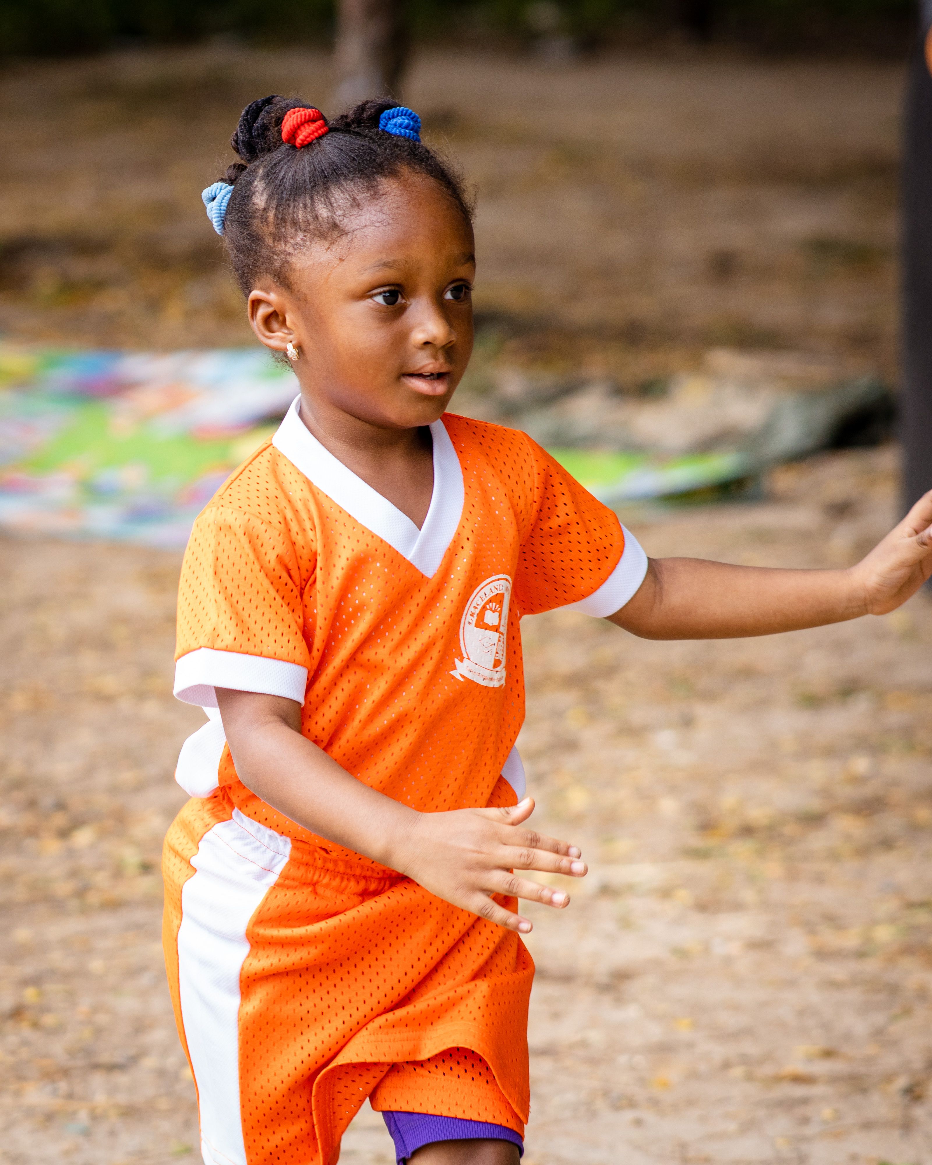 A Girl Wearing an Orange Uniform · Free Stock Photo