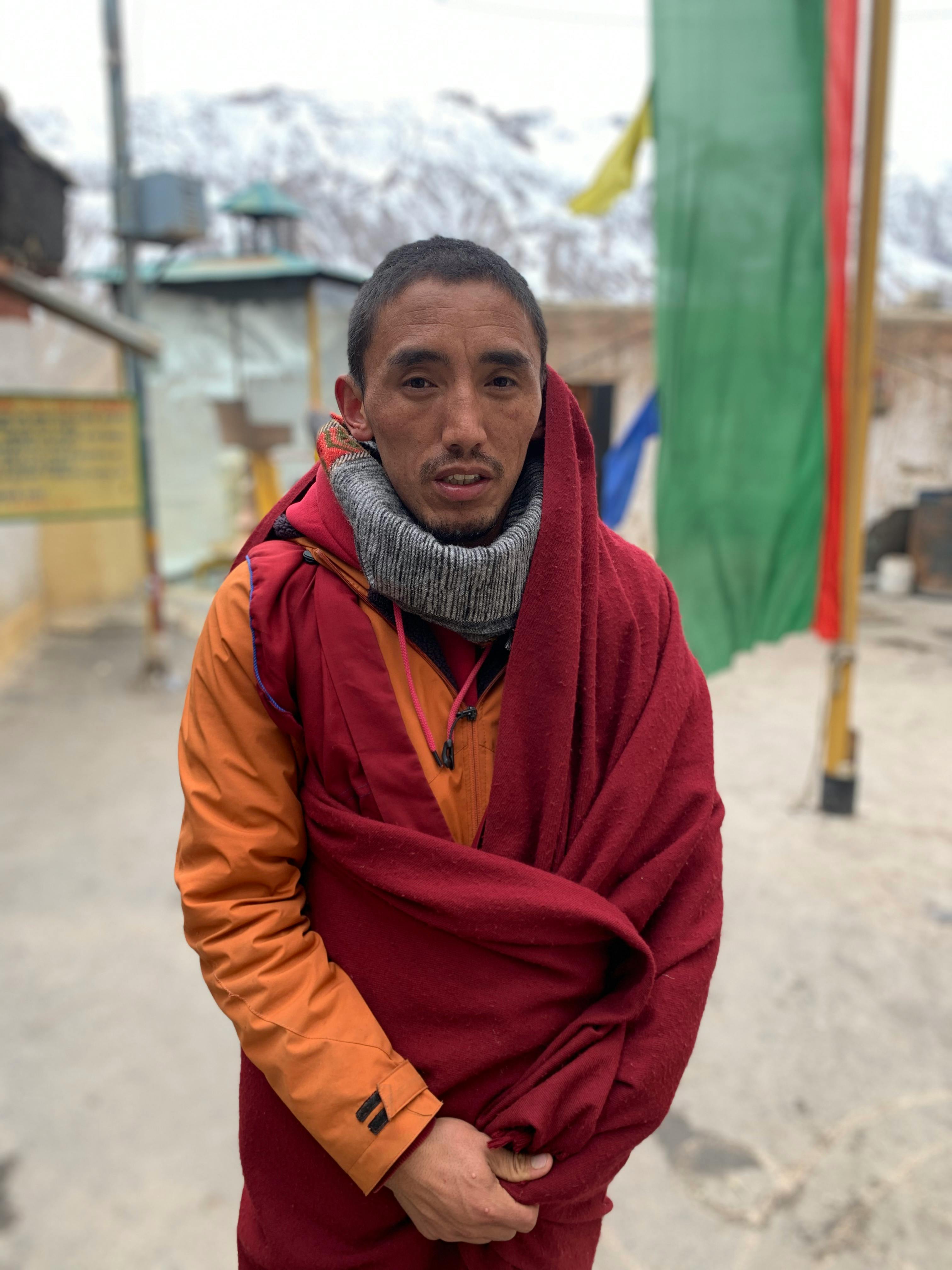 Man in Yellow Robe Holding Book · Free Stock Photo