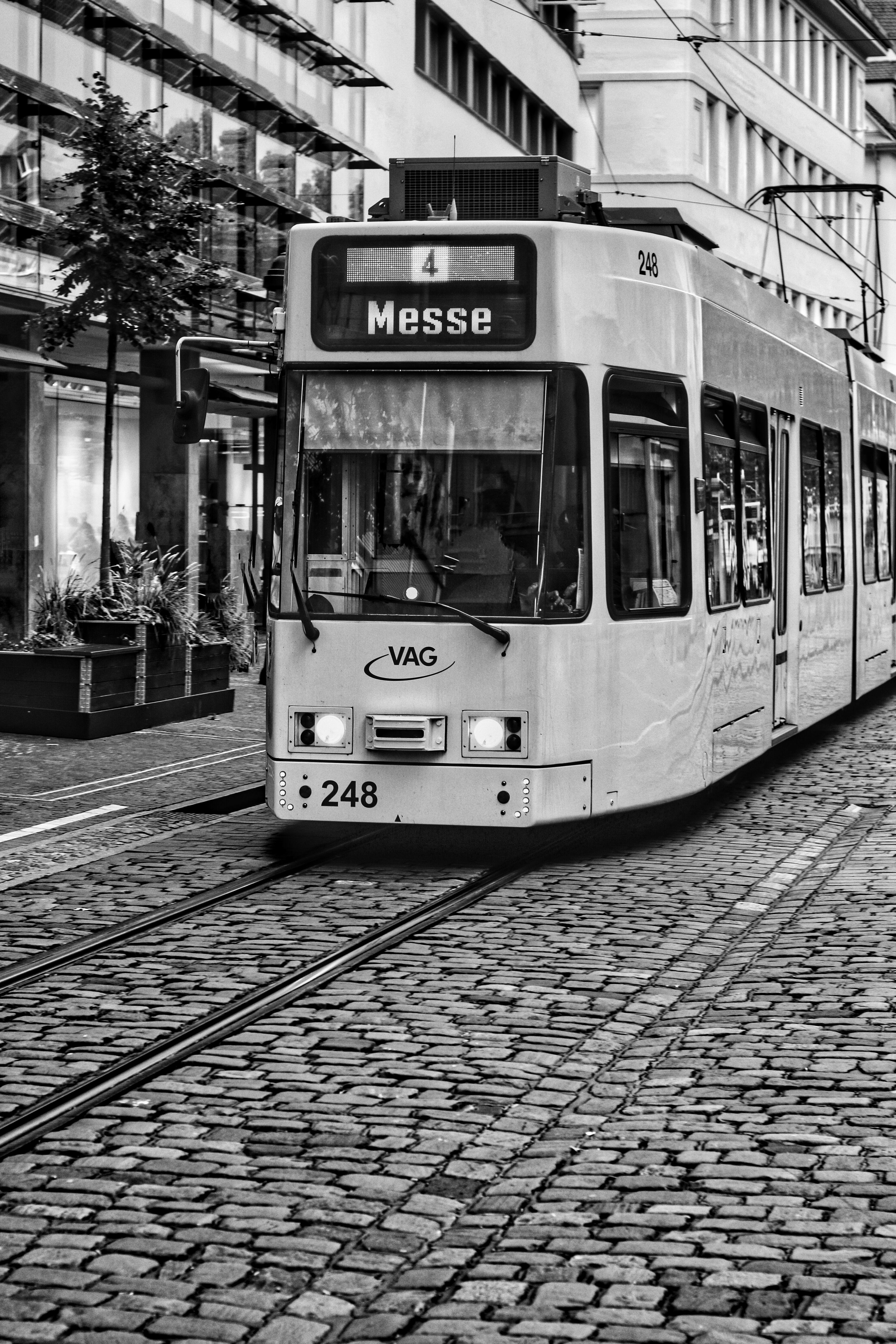 A Grayscale of a Tram on a Street with a Cobblestone Pavement · Free ...