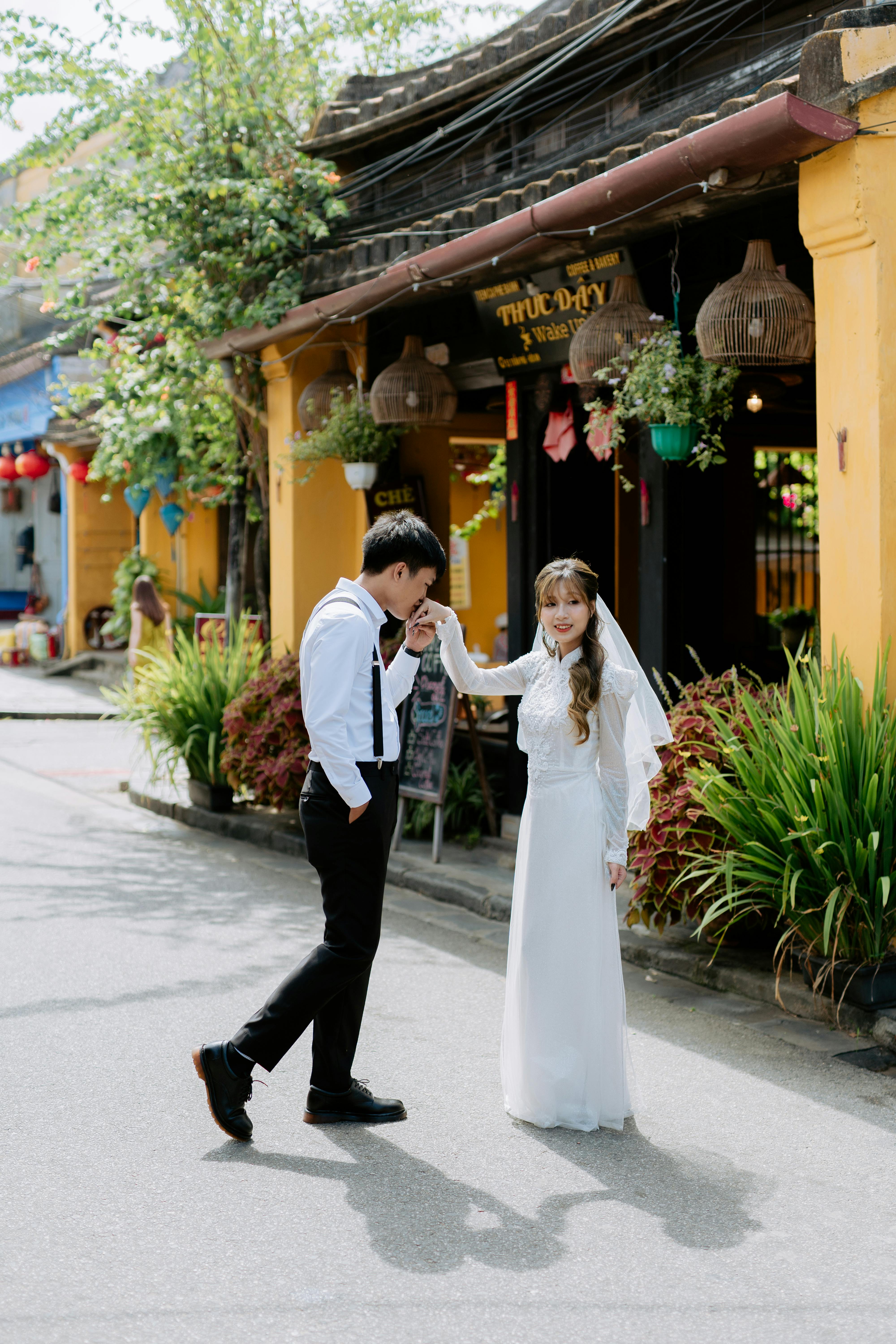 Bridegroom Kissing the Bride in Hand · Free Stock Photo