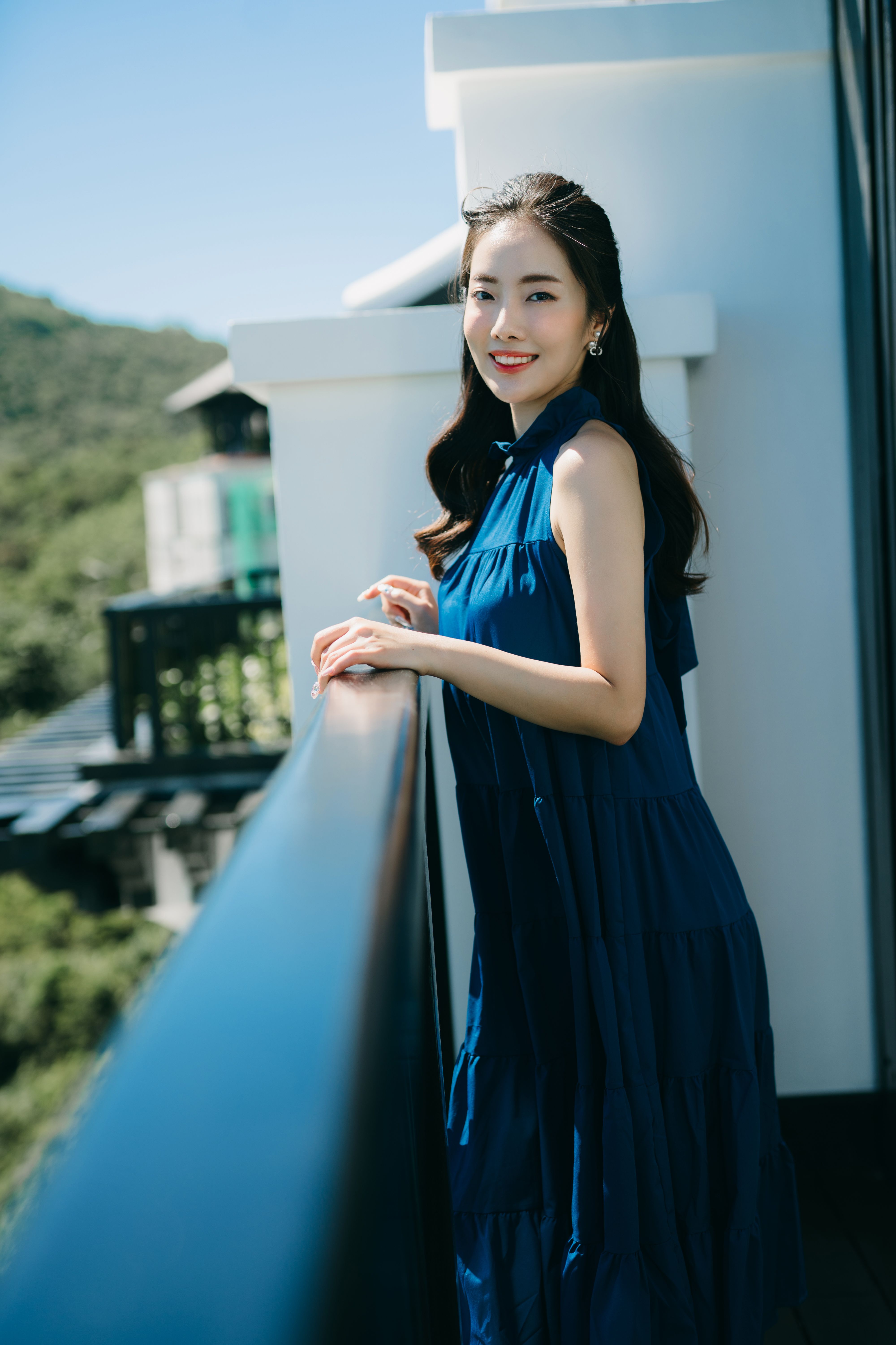 Woman on Balcony Overlooking Sea · Free Stock Photo