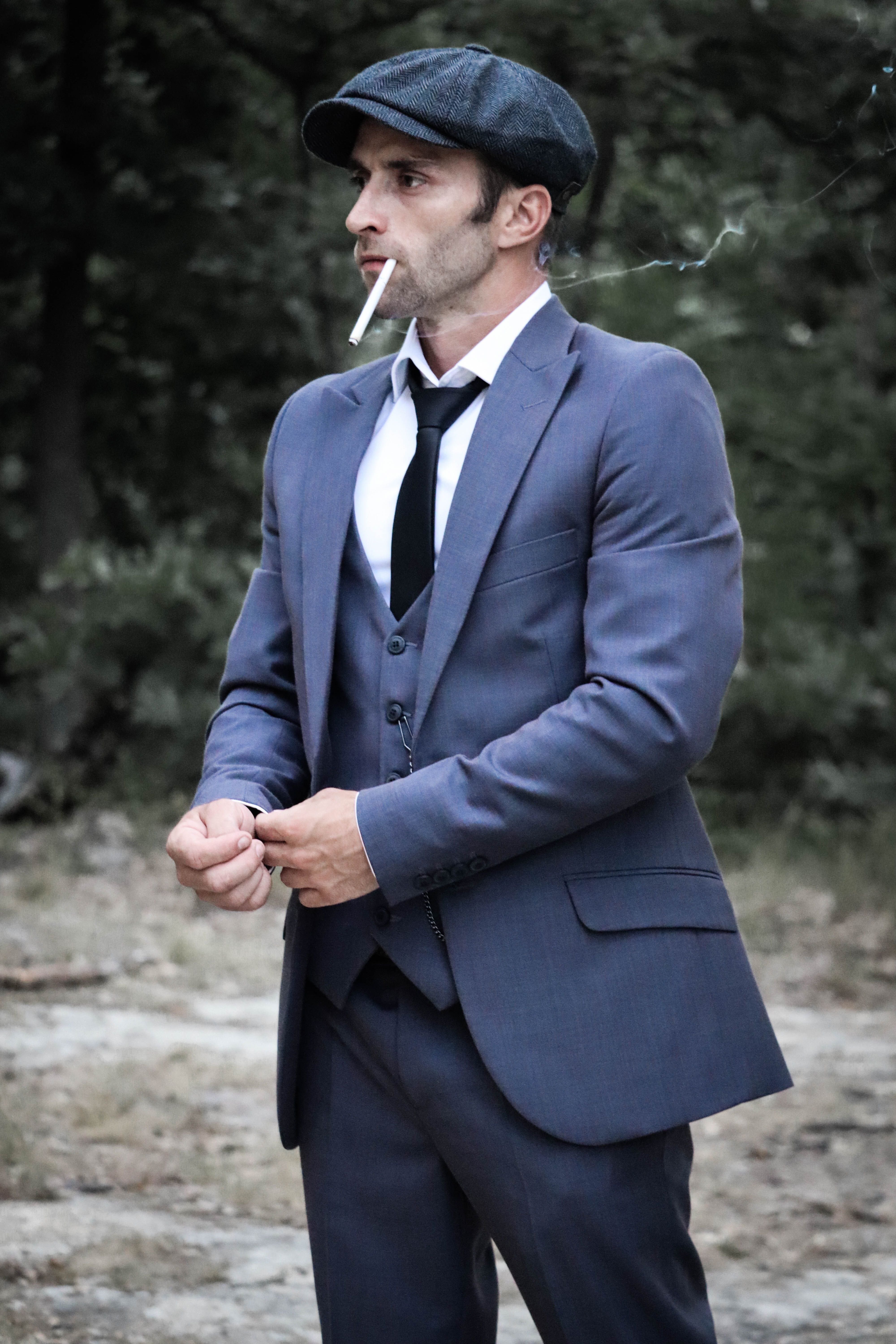 Portrait of a Man with Curly Hair Smoking a Cigarette · Free Stock Photo
