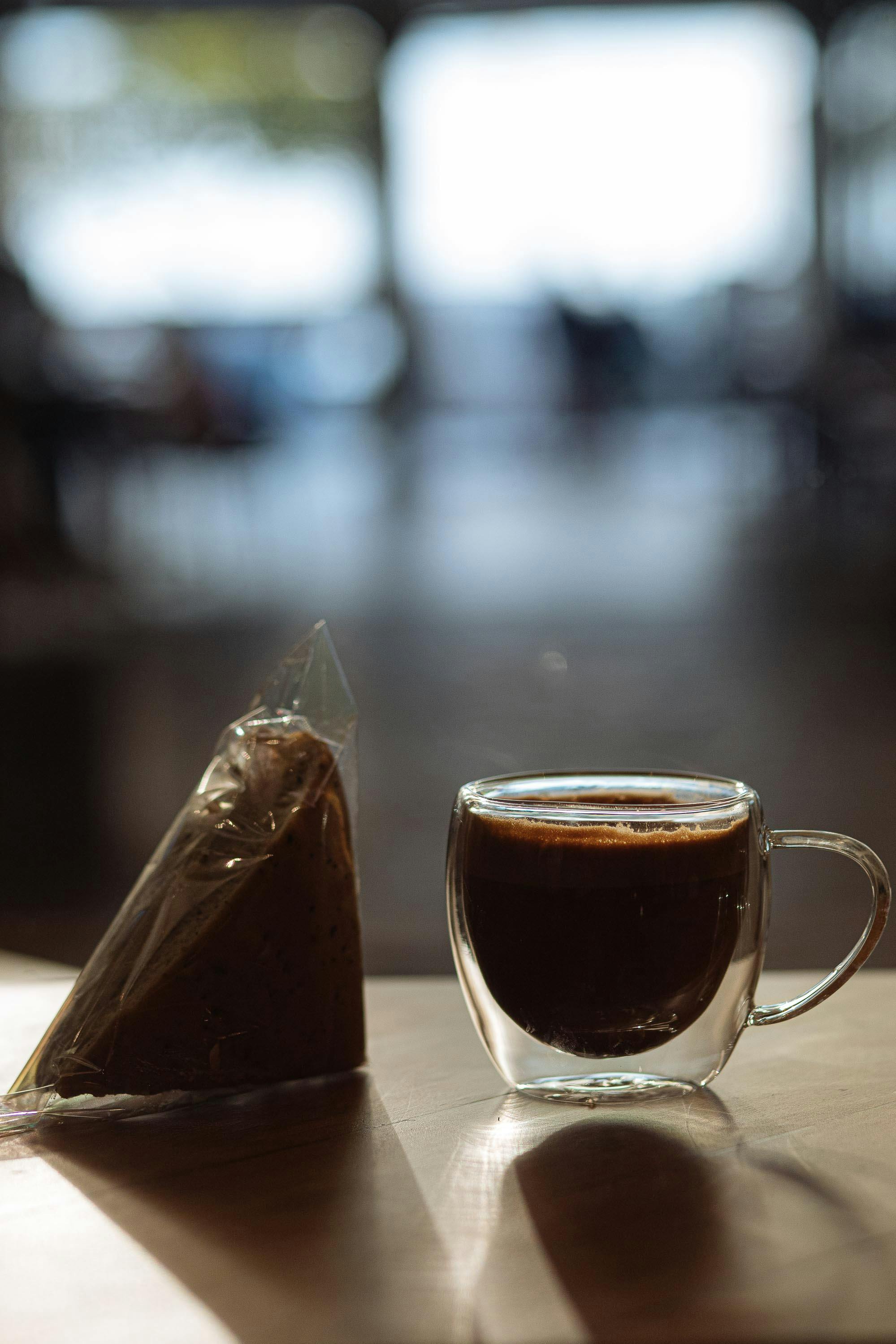 Coffee in Glass Cup and Package in Nature · Free Stock Photo