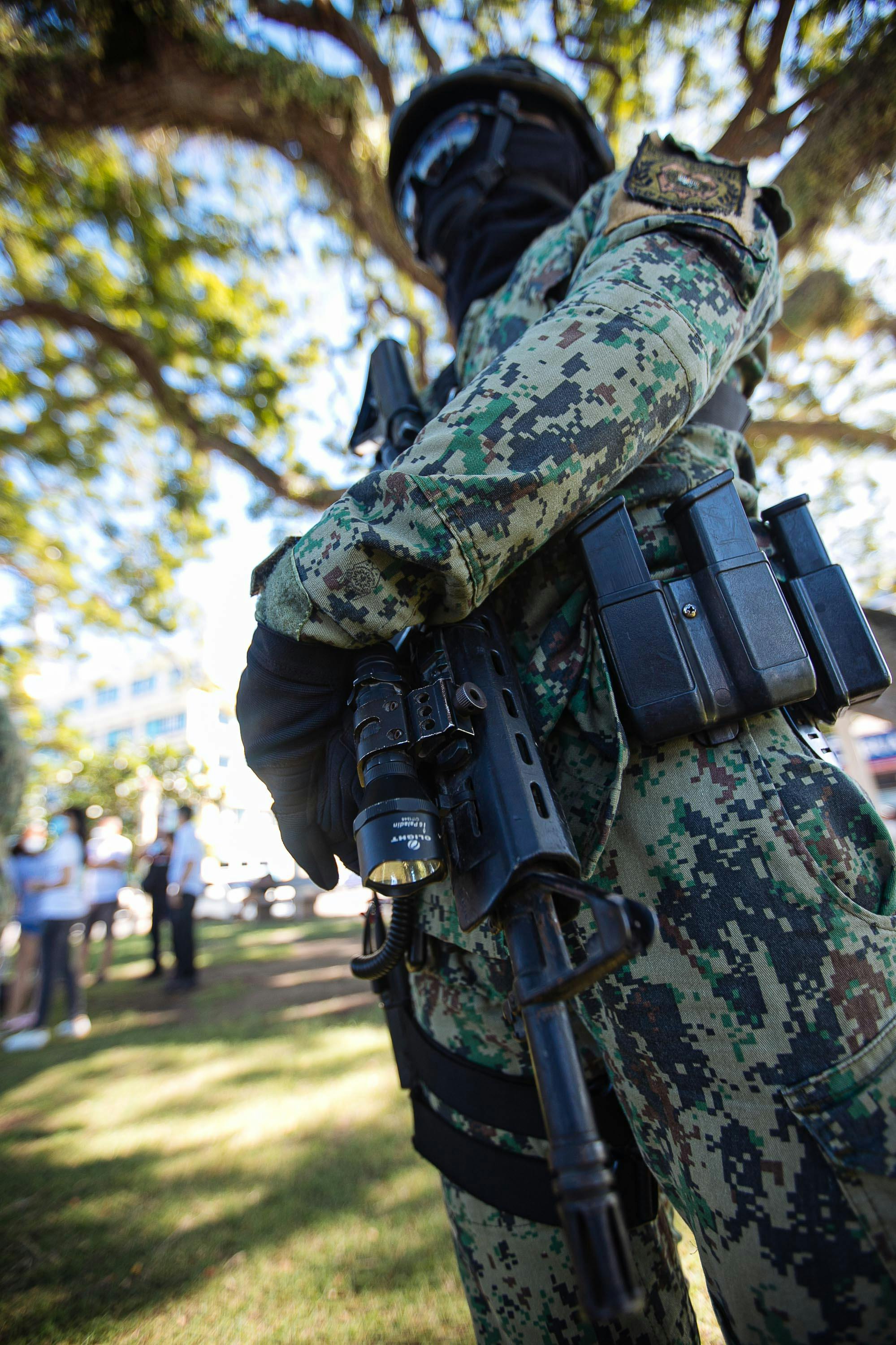 A Military Personnel Holding a Rifle · Free Stock Photo