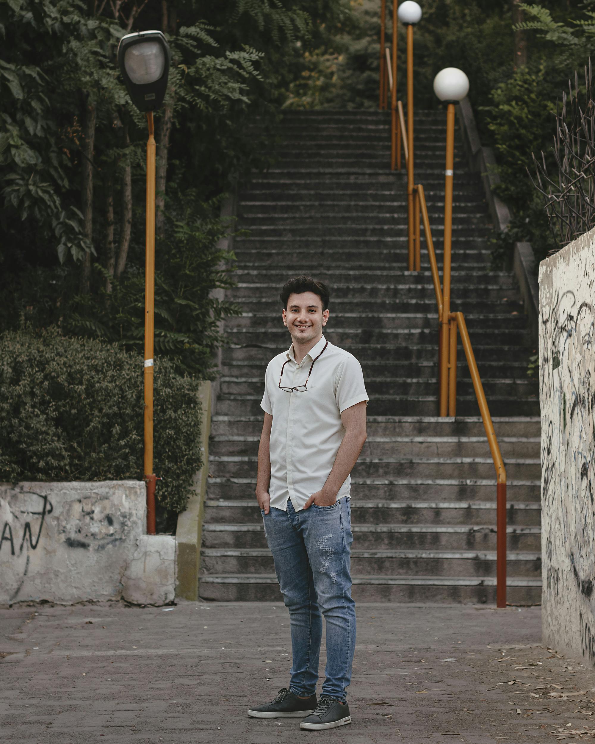 A Man in White Polo Shirt Standing on the Street · Free Stock Photo