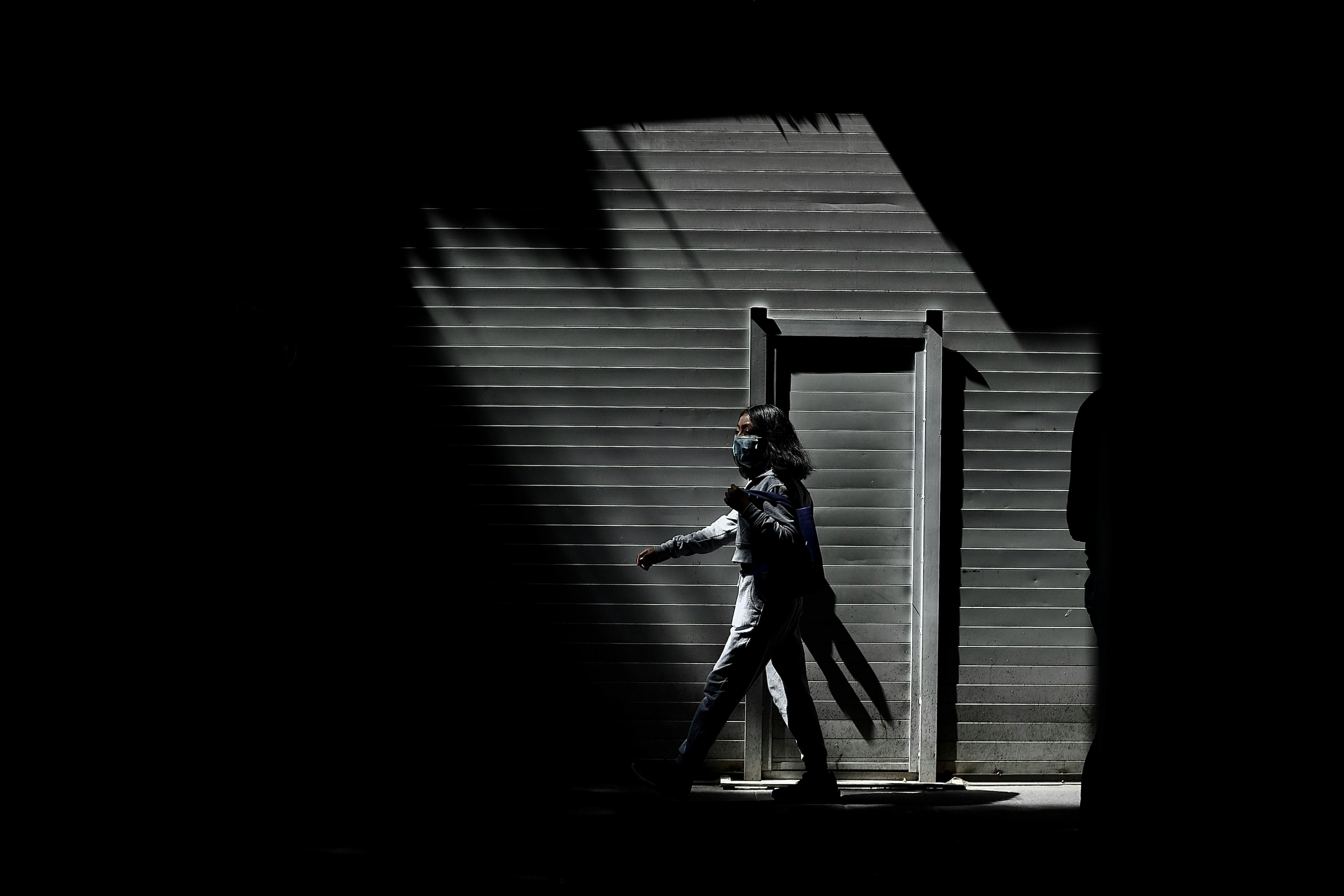 Woman with a Face Mask Walking on the Sidewalk · Free Stock Photo
