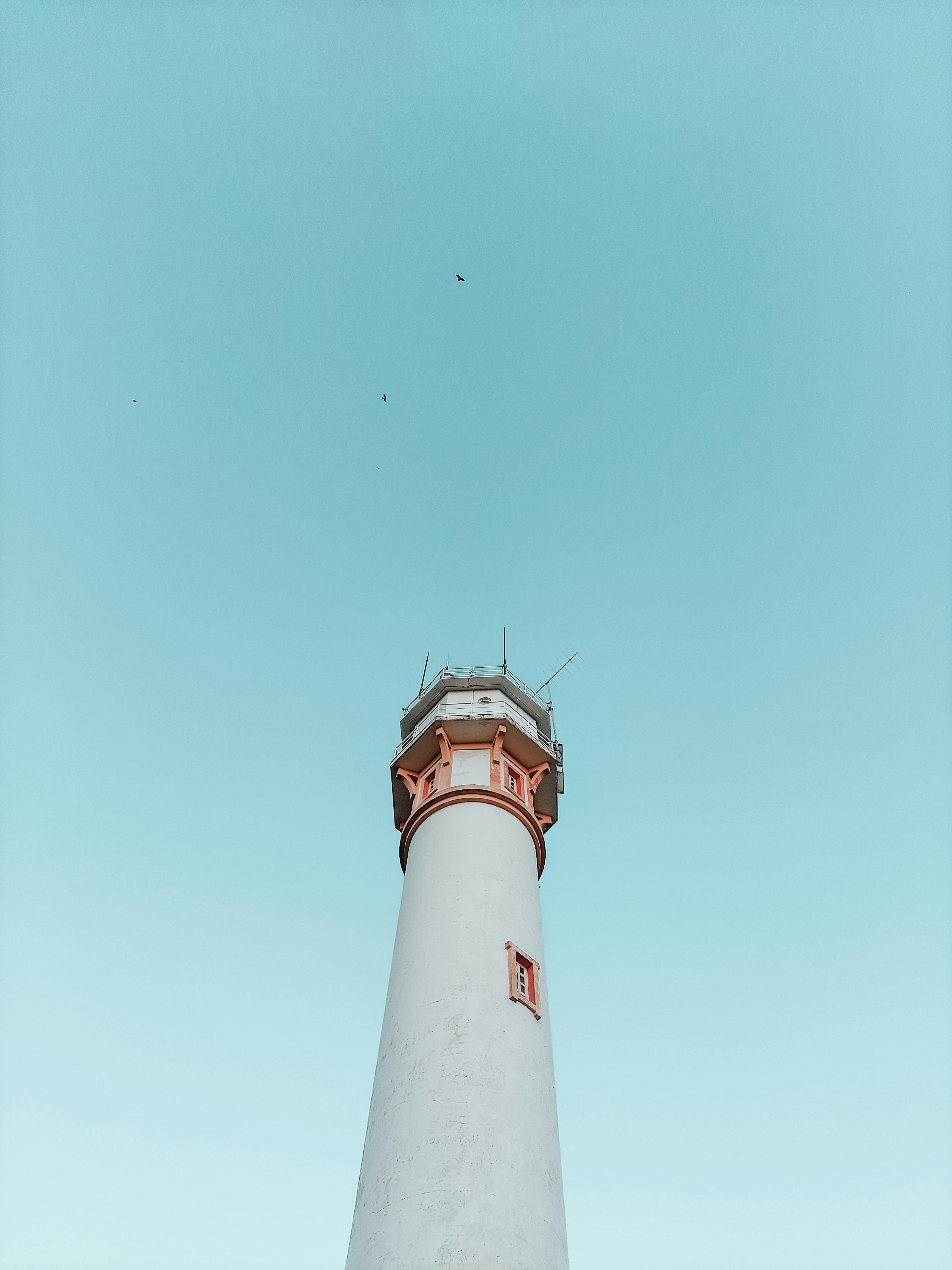 A Lighthouse Under the Blue Sky · Free Stock Photo