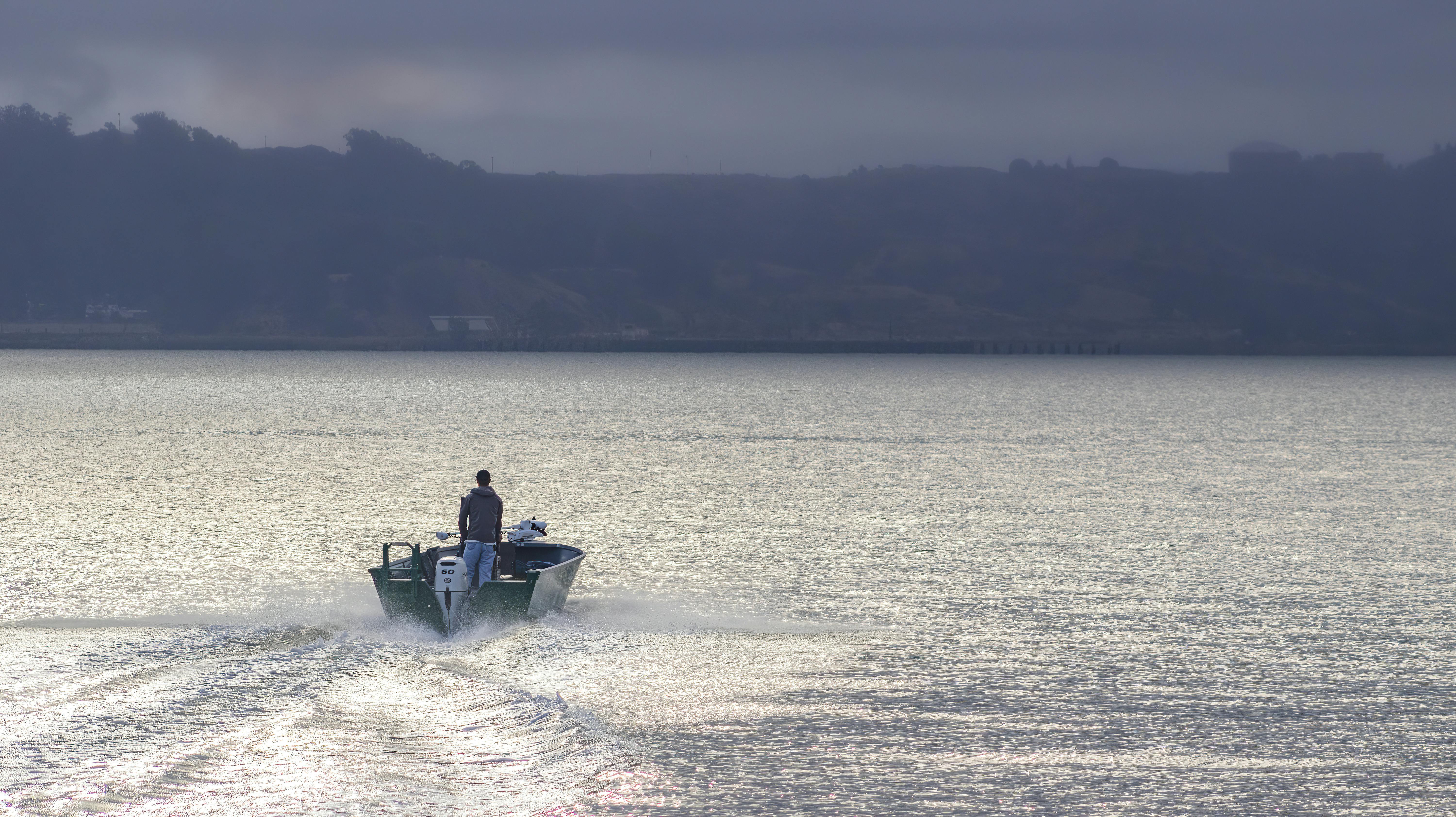 Man Riding a Boat on the Sea · Free Stock Photo