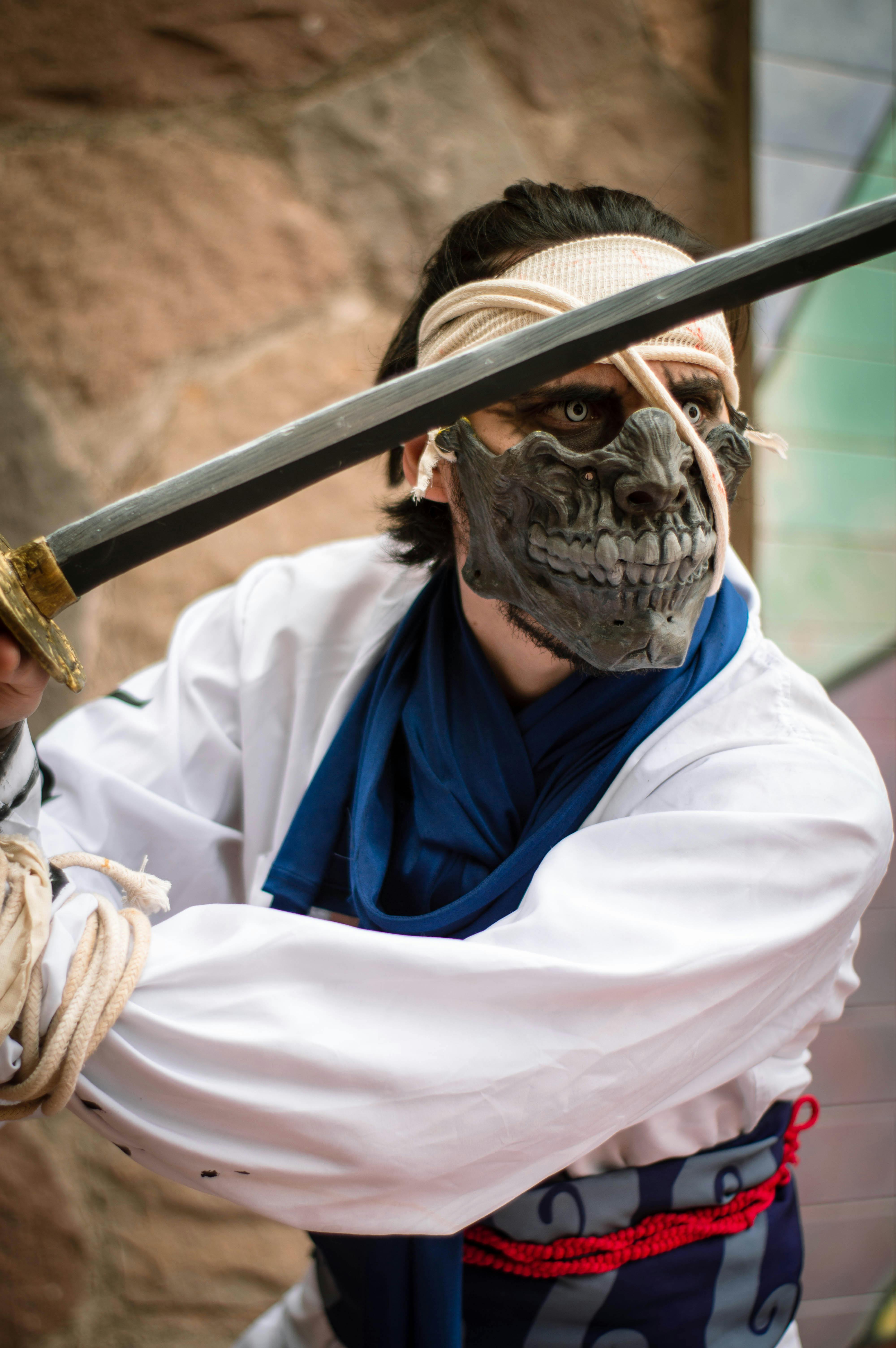 Person in Samurai Ryuma Costume Holding Sword · Free Stock Photo