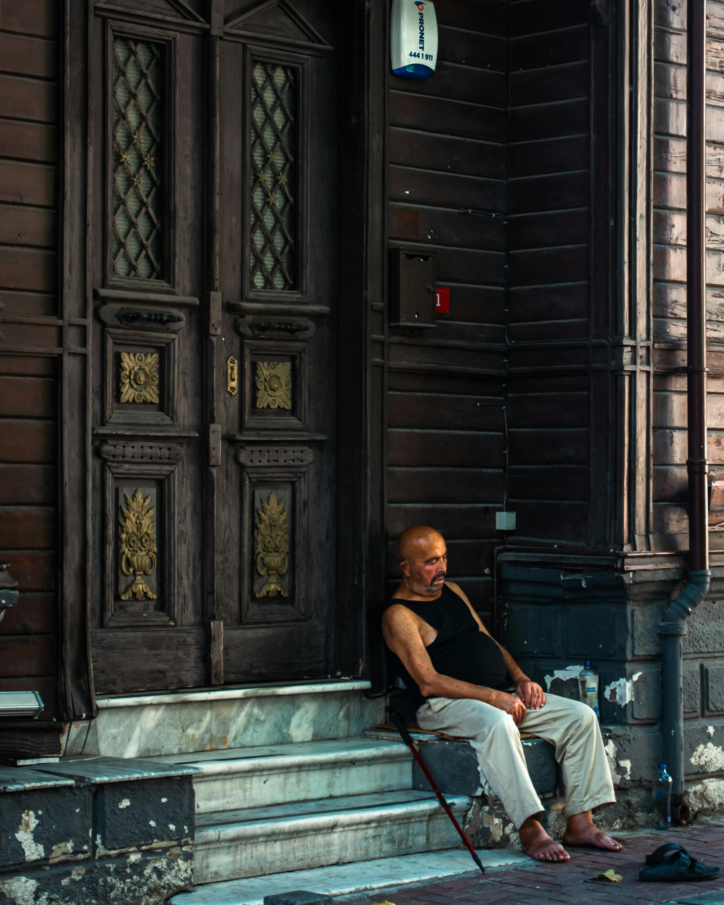 Man Sitting on the Steps in Front of the Door and Taking a Nap · Free ...
