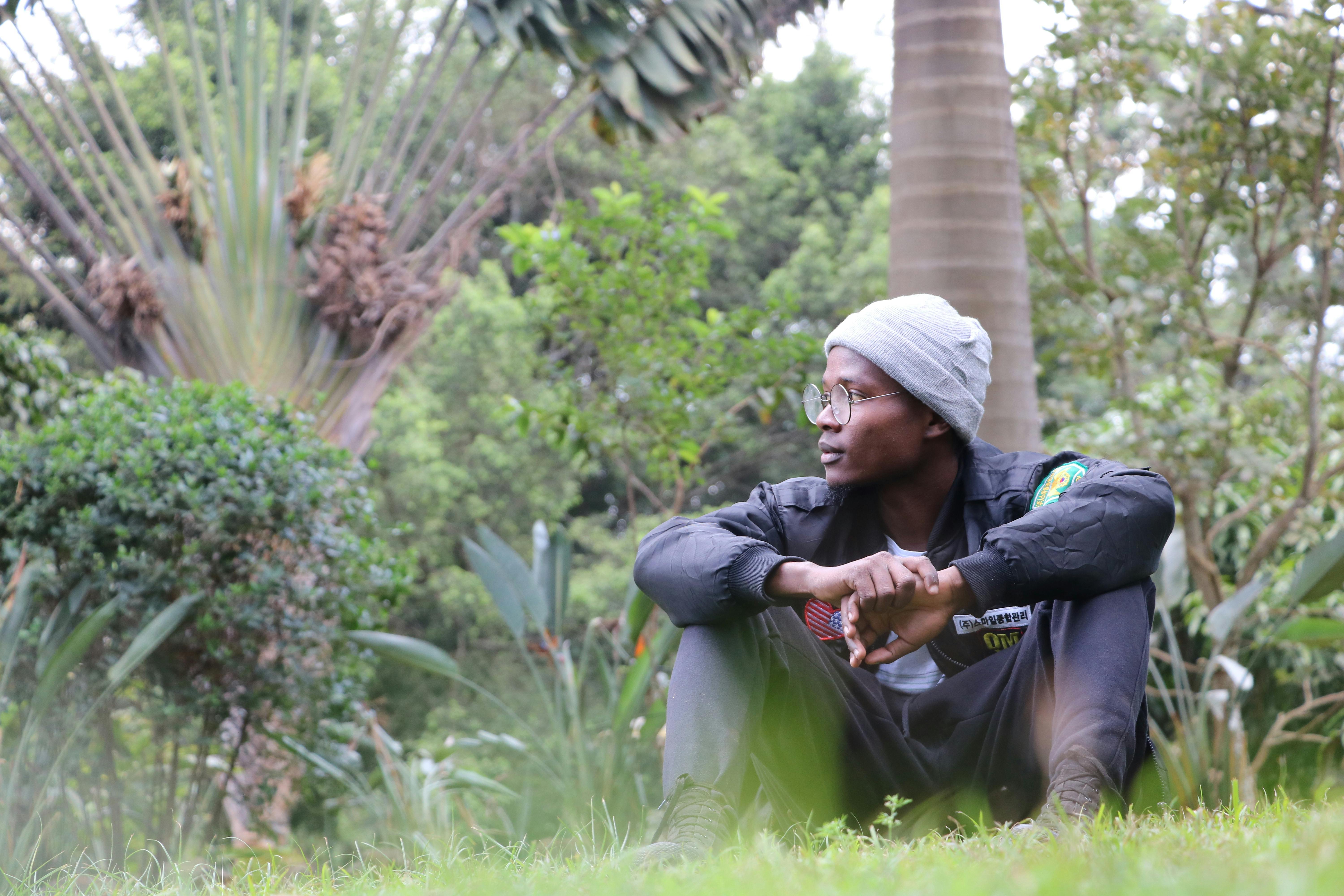 Person Sitting on the Grass Lawn · Free Stock Photo