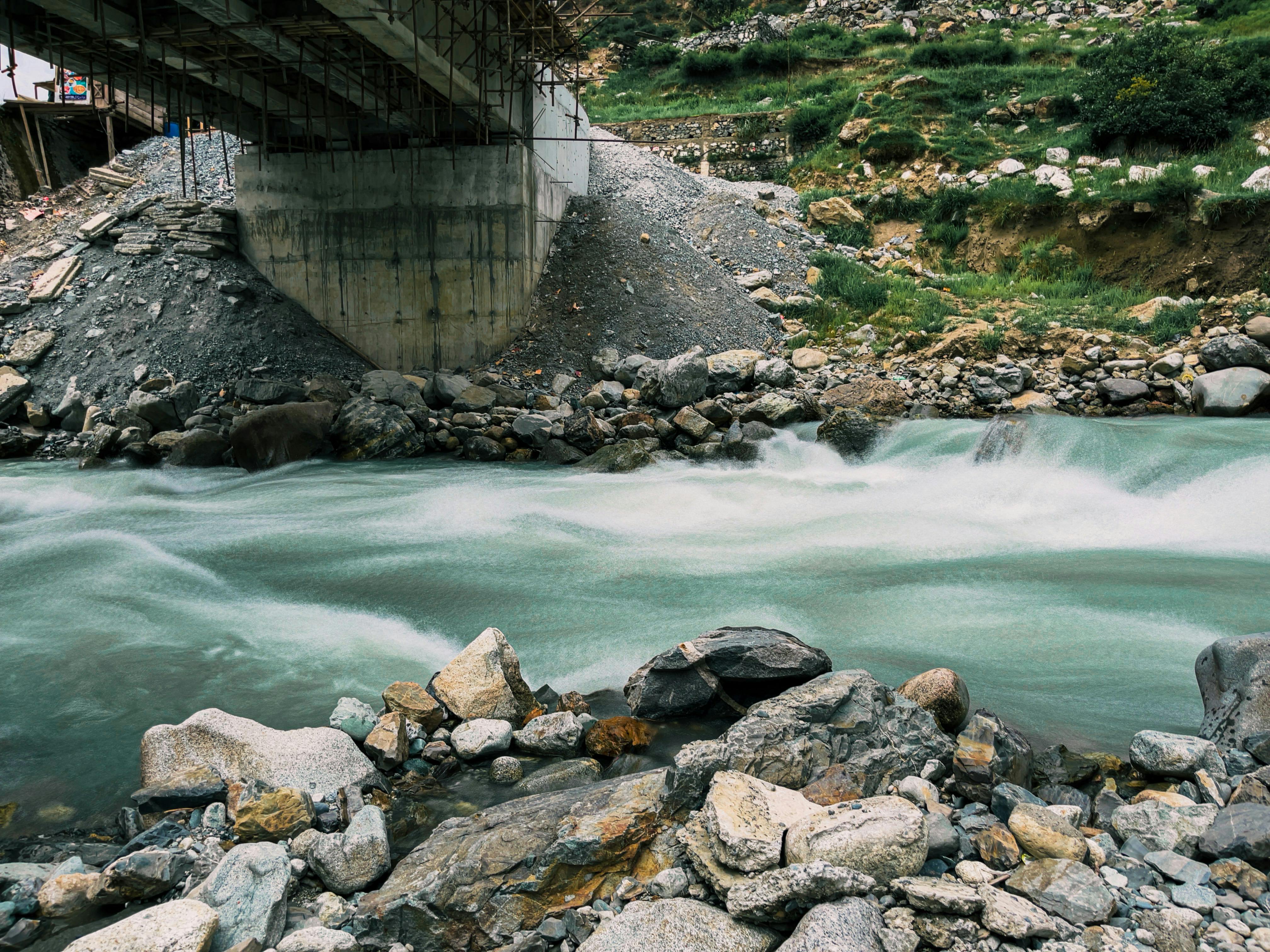 River Flowing under Bridge · Free Stock Photo