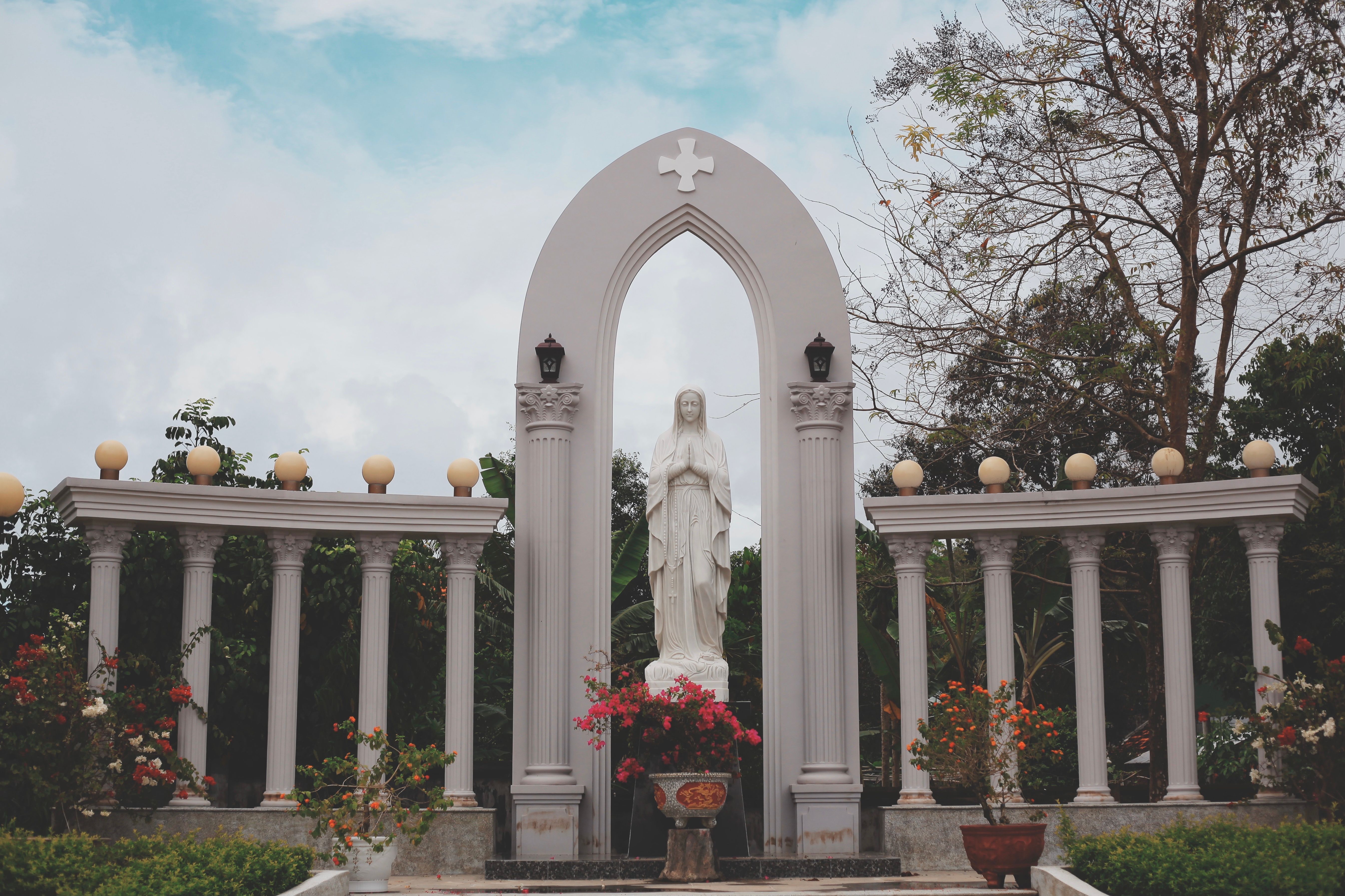 Brown Concrete Statue Near Green Trees · Free Stock Photo
