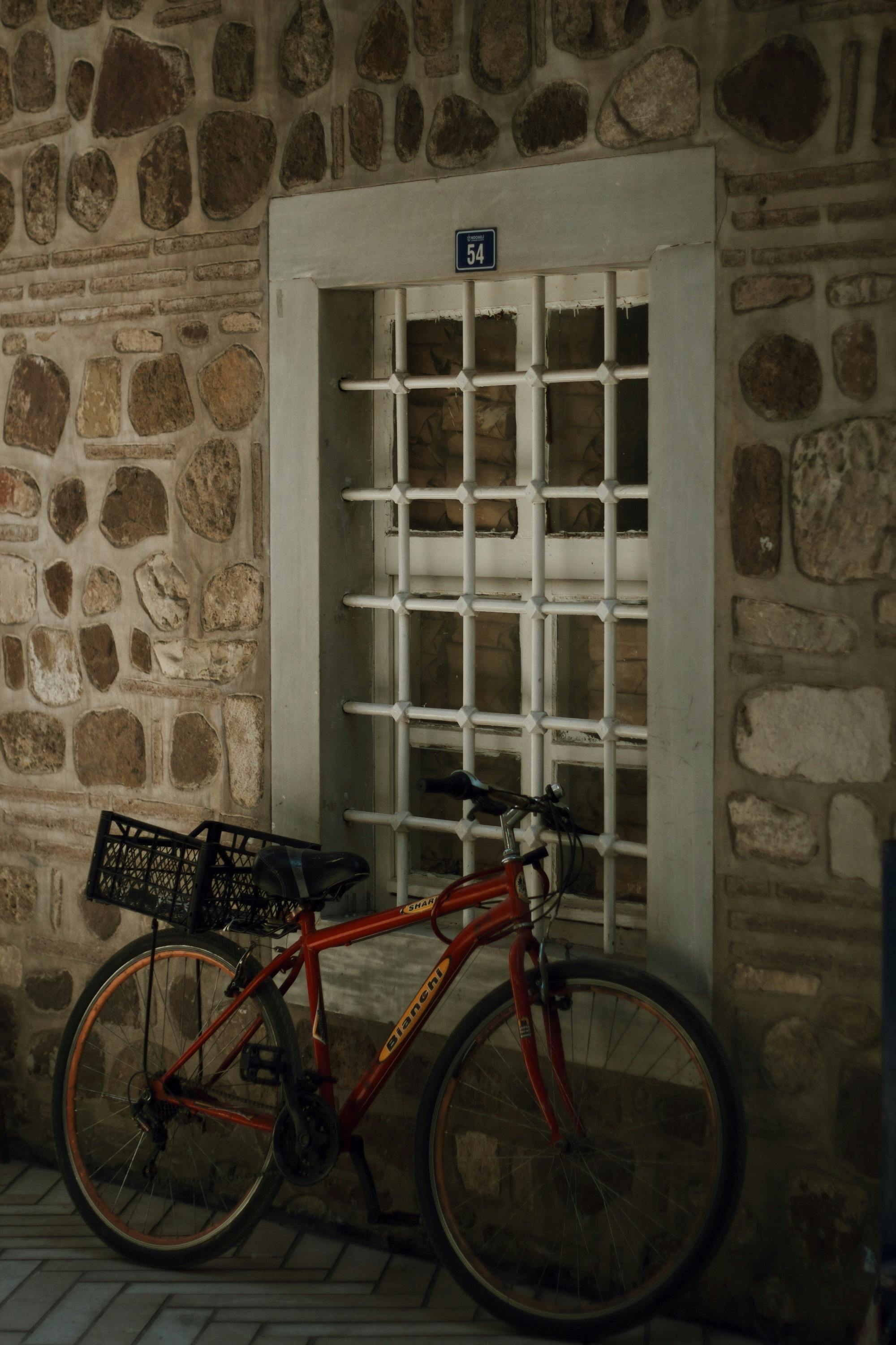 Bicycle Wheel Beside a Window · Free Stock Photo