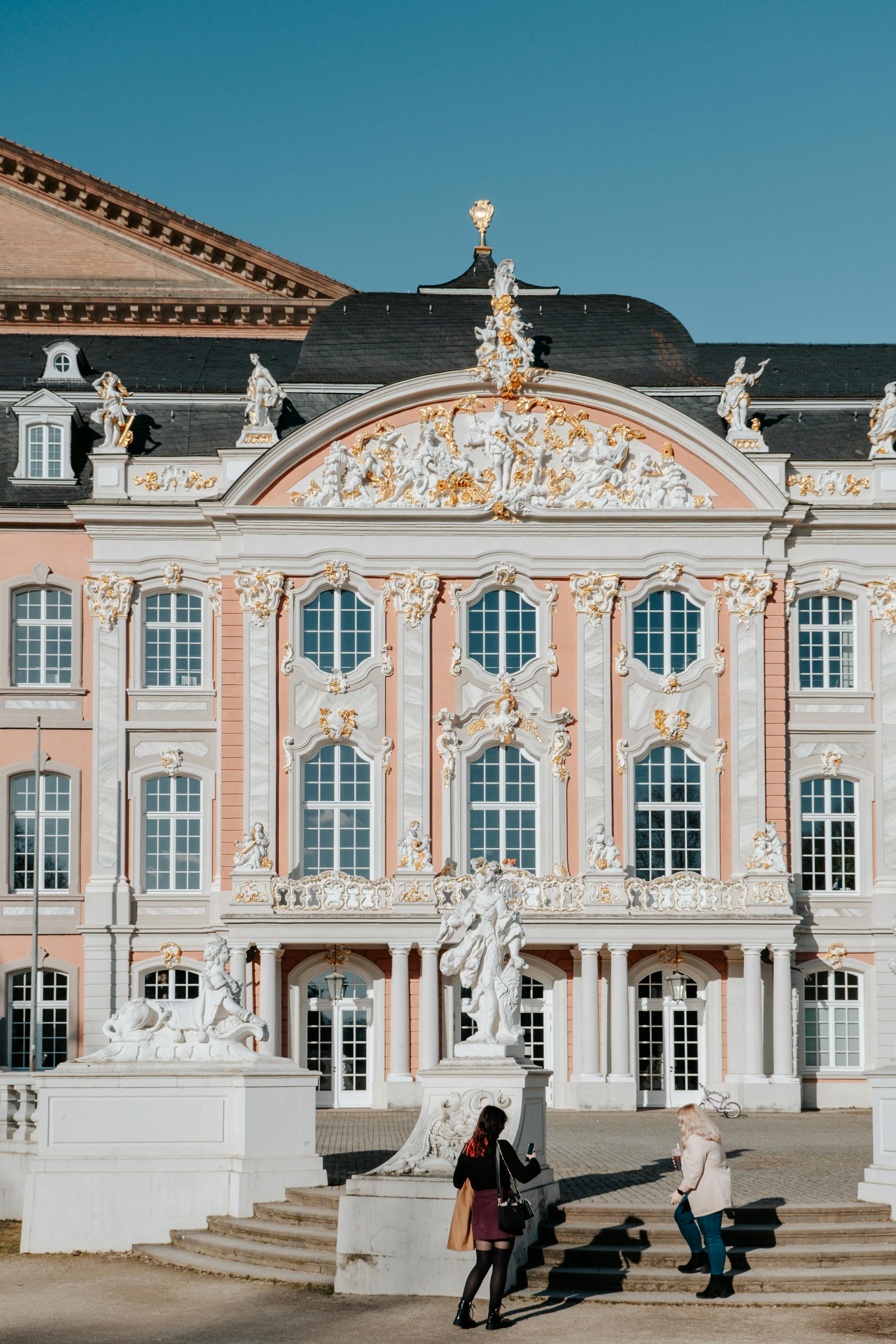 Photography of Two Person Statue Above on Building · Free Stock Photo