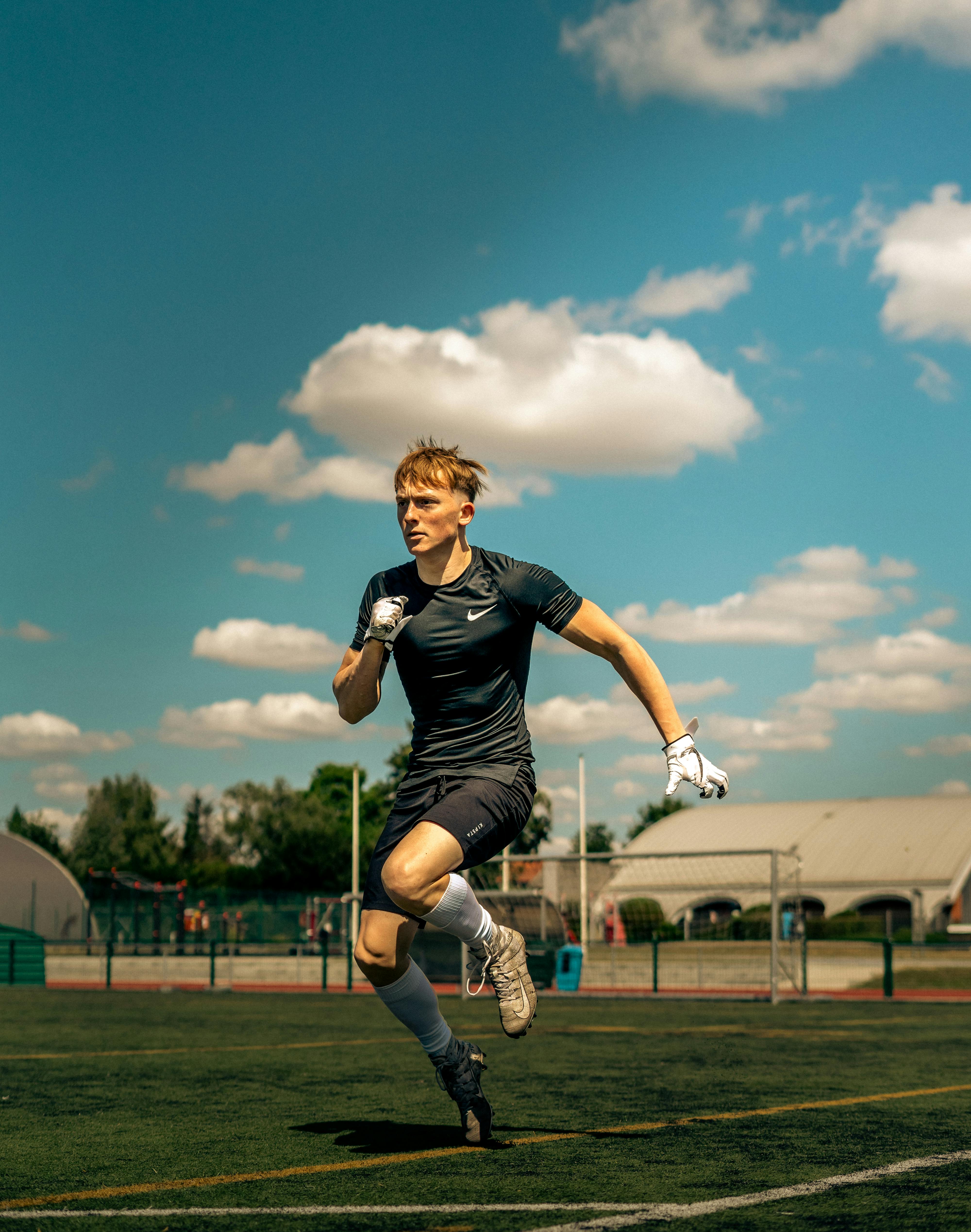 Athlete Running on Stadium · Free Stock Photo