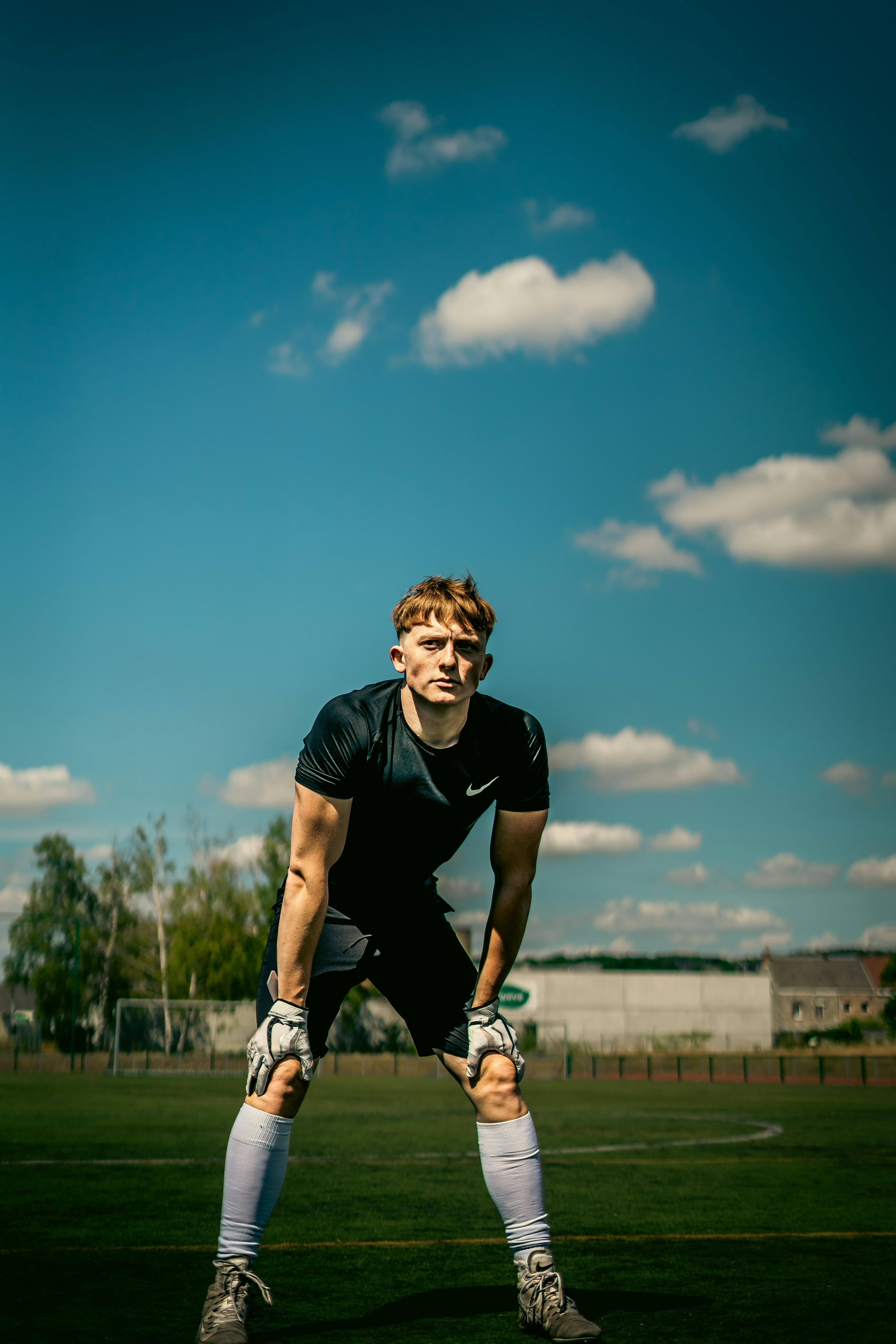 Goalkeeper Standing on Football Field · Free Stock Photo