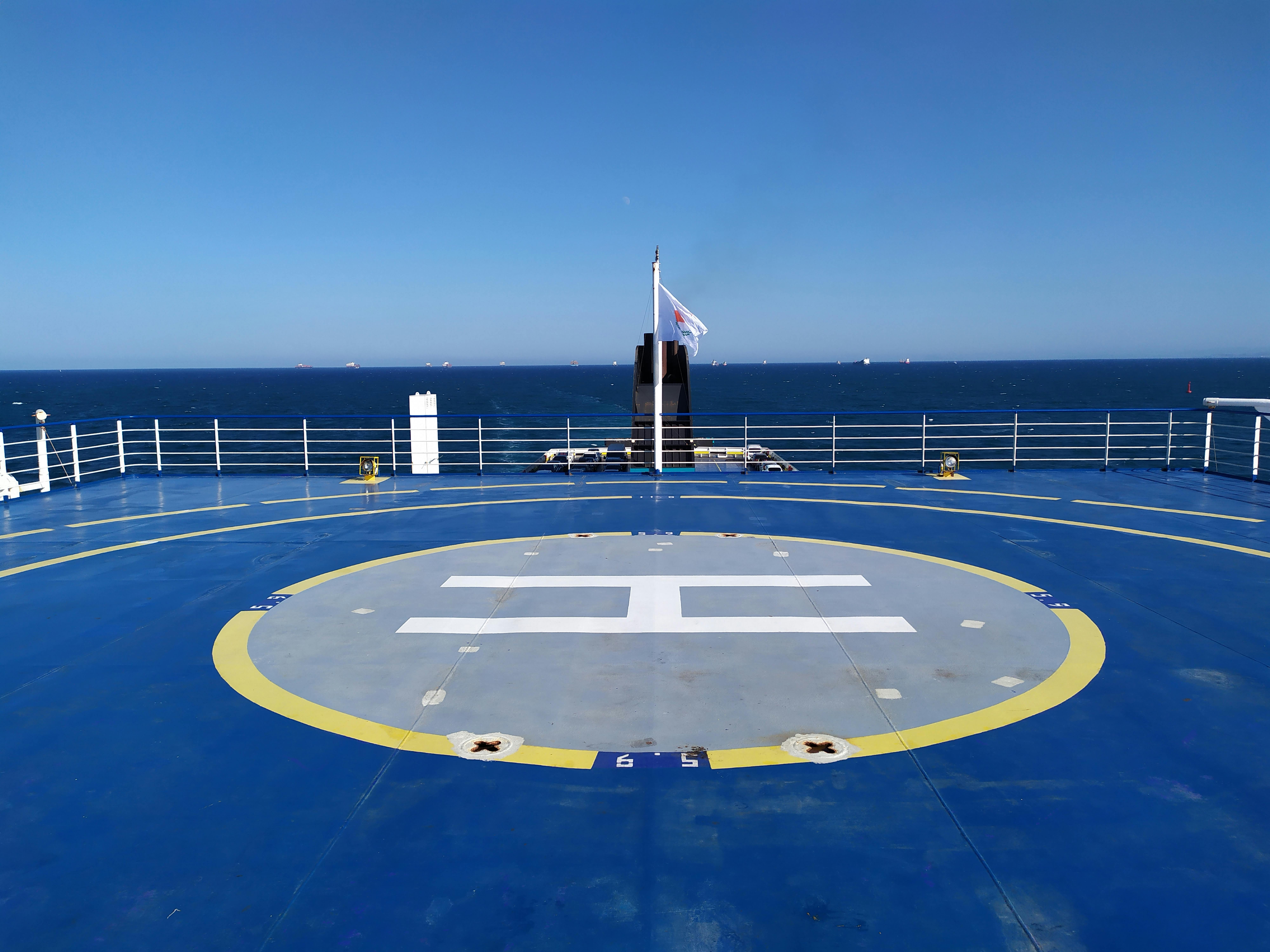 Sunlit Helipad on Sea Coast · Free Stock Photo