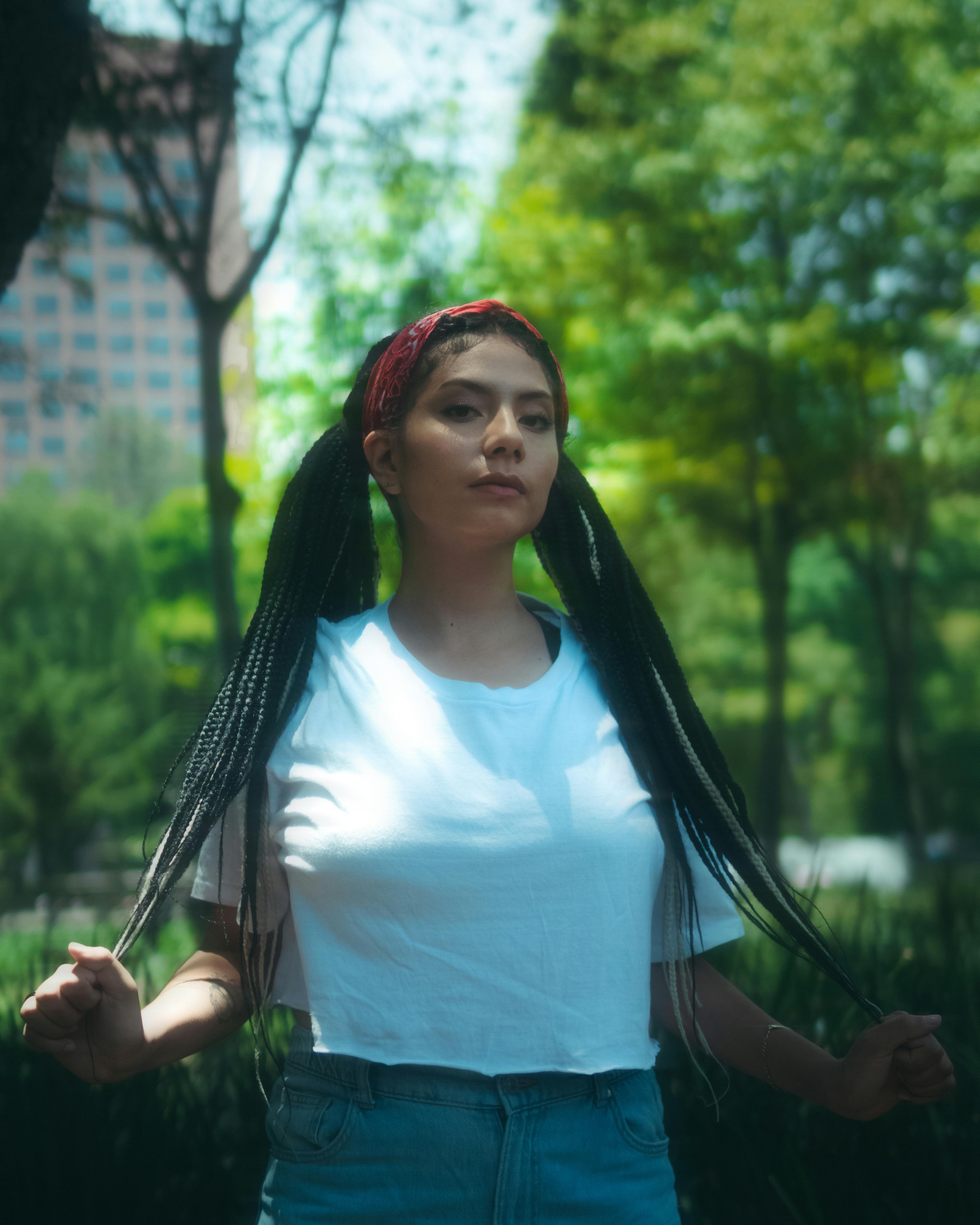 Faceless ethnic person touching long African braids · Free Stock Photo