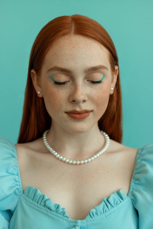 Portrait Of A Young Beautiful Redhead Woman Wearing Pearls · Free Stock