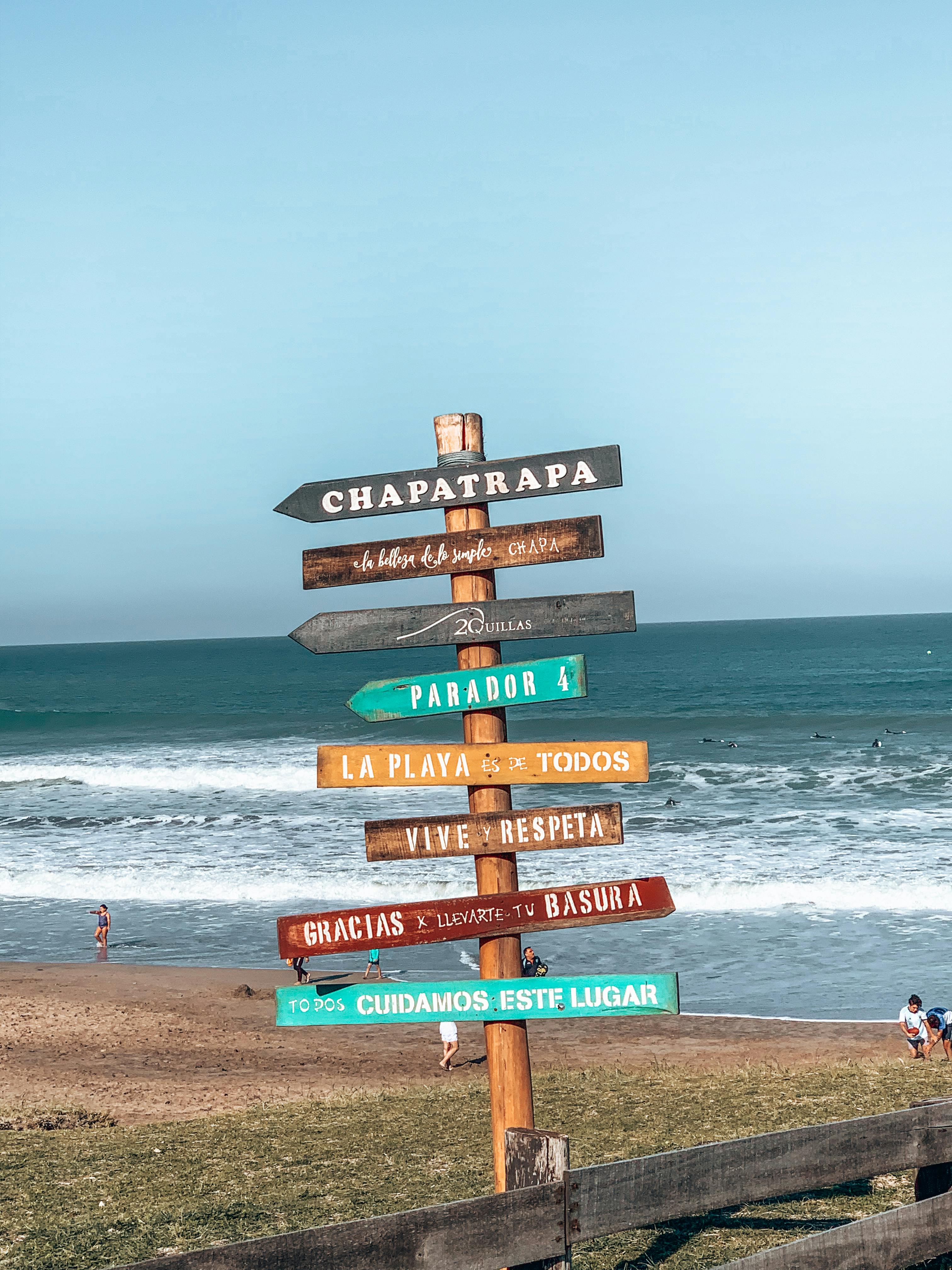 Multicoloured Wooden Directional Signs by the Sea · Free Stock Photo