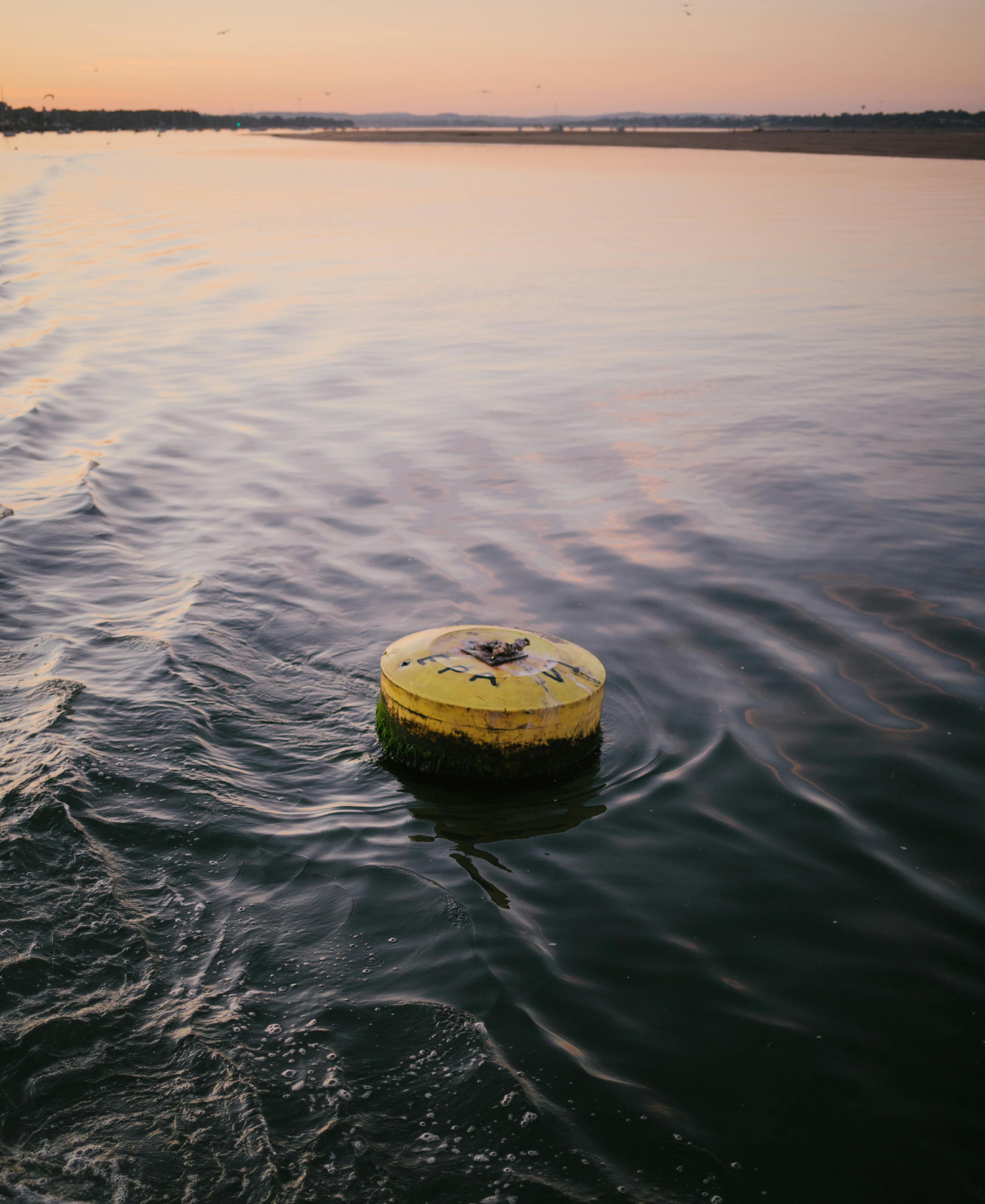 A Buoy in Water at Sunset · Free Stock Photo