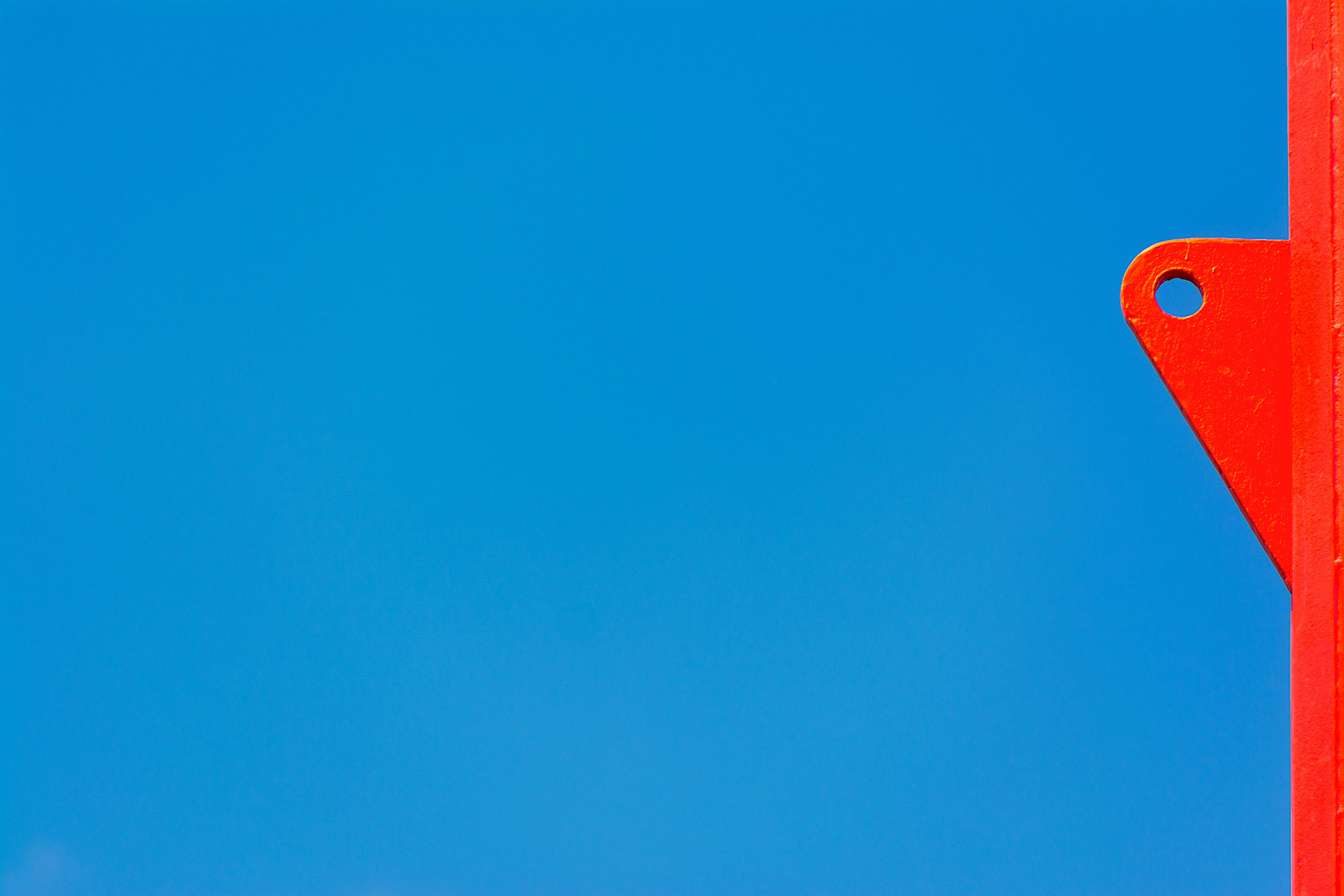 Red Metal Post Near Blue Background · Free Stock Photo