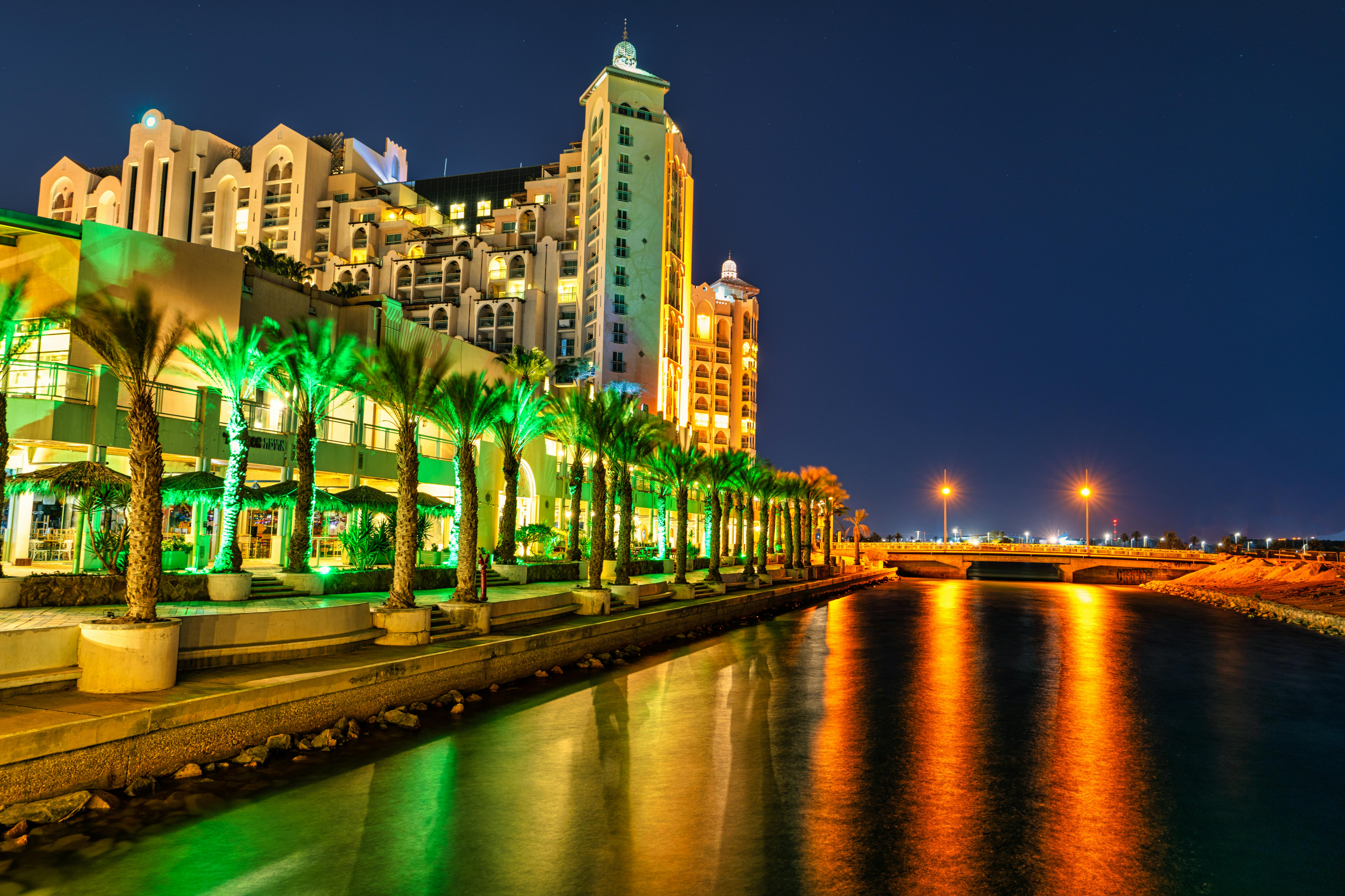 Illuminated Buildings on Boardwalk at Night · Free Stock Photo