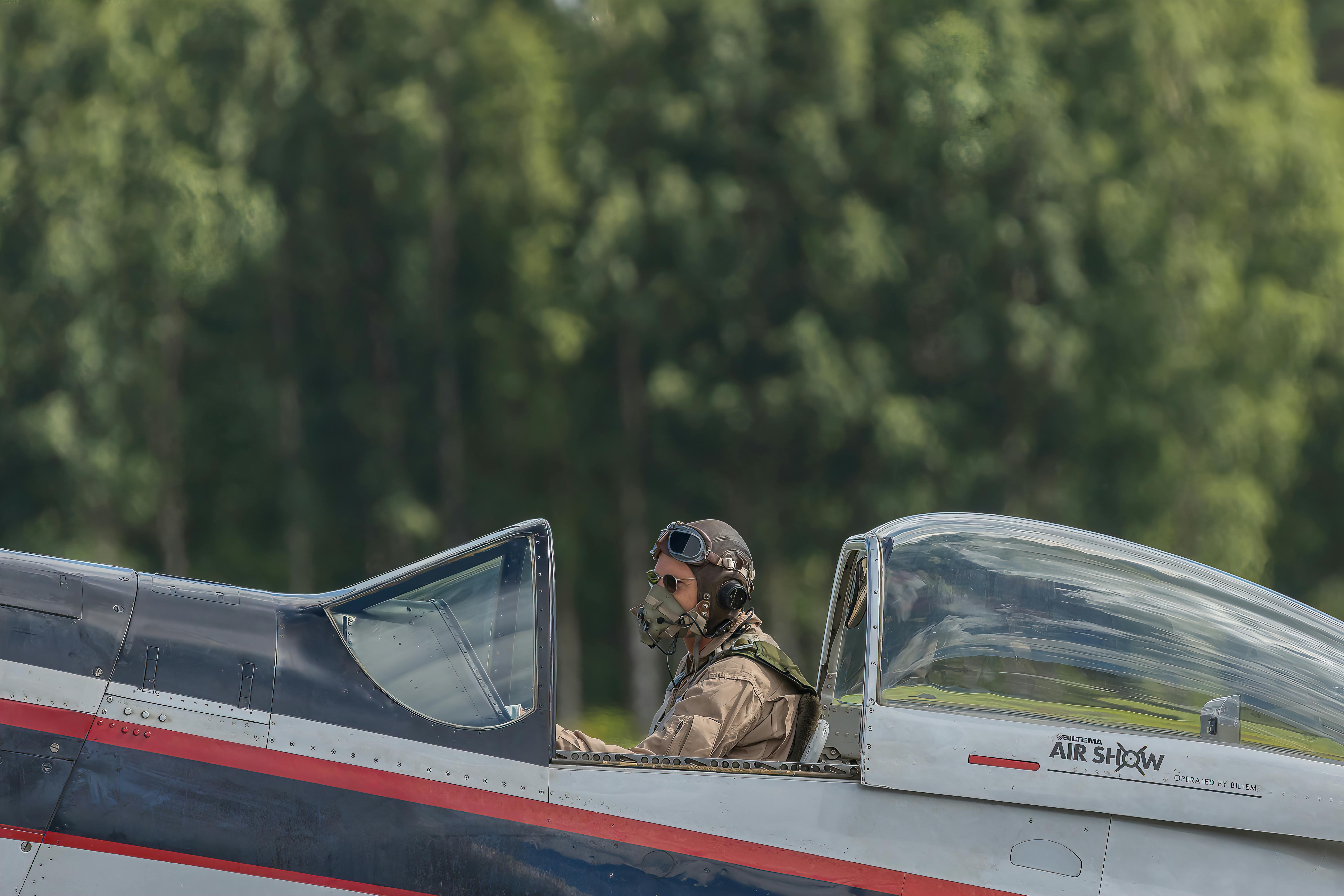 Pilot Sitting on Air Fighter Jet Wearing Gas Mask · Free Stock Photo