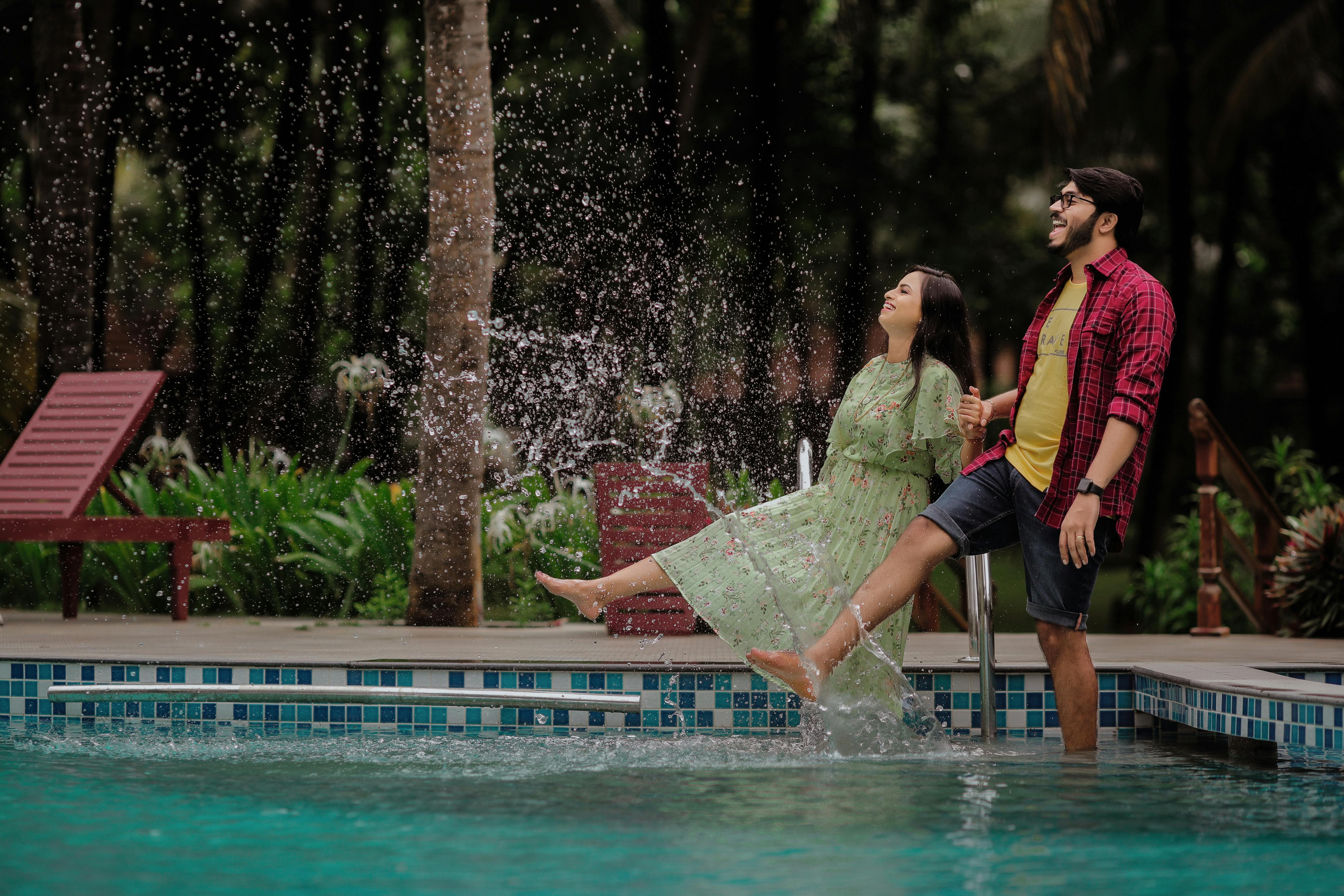 A Couple Holding Hands Near a Swimming Pool · Free Stock Photo