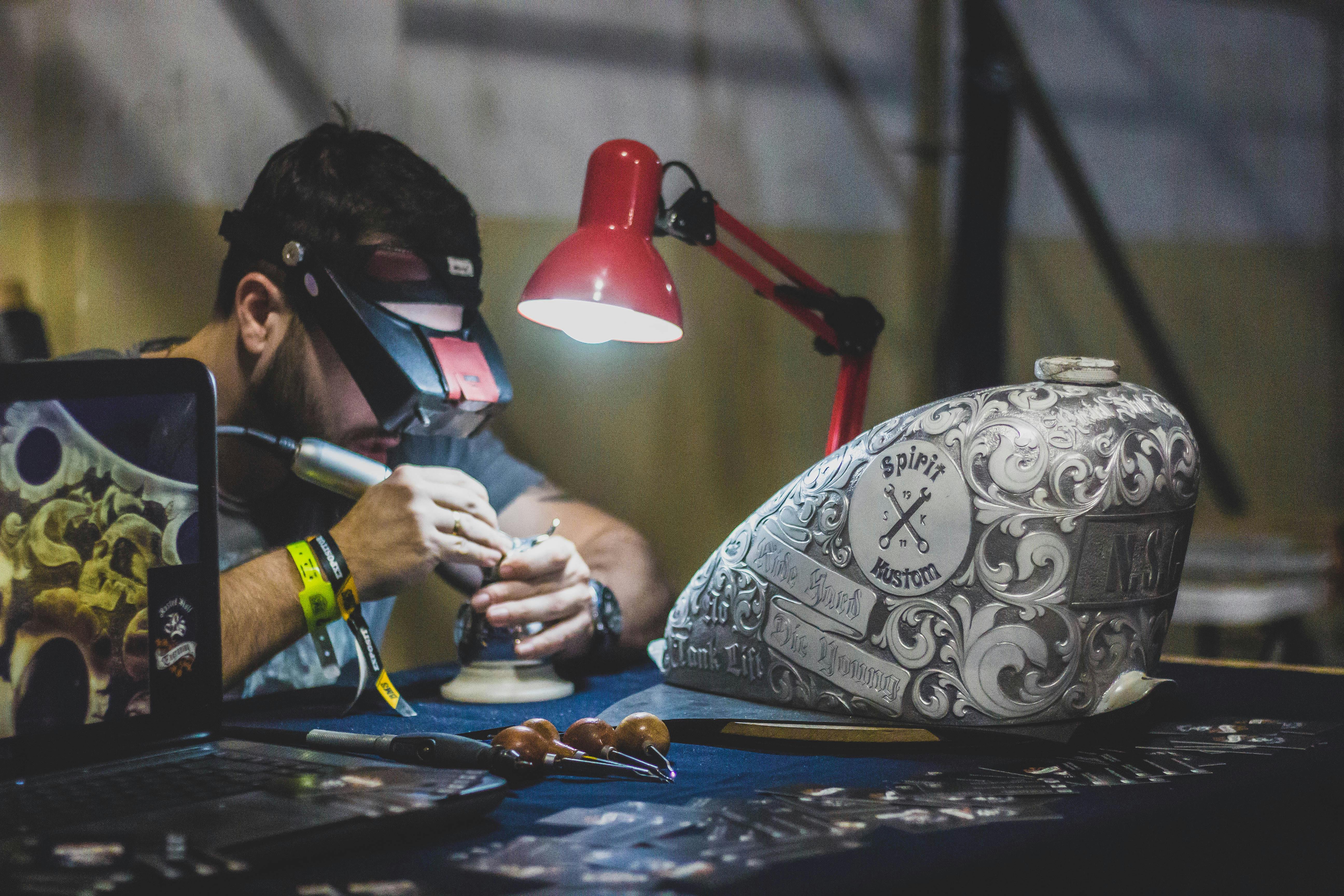 Artist Sitting by Table and Working · Free Stock Photo