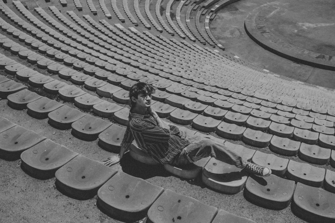 Grayscale Photography of a Man Sitting on the Seat of a Stadium · Free ... Grayscale Photography of a Man Sitting on the Seat of a Stadium · Free ...