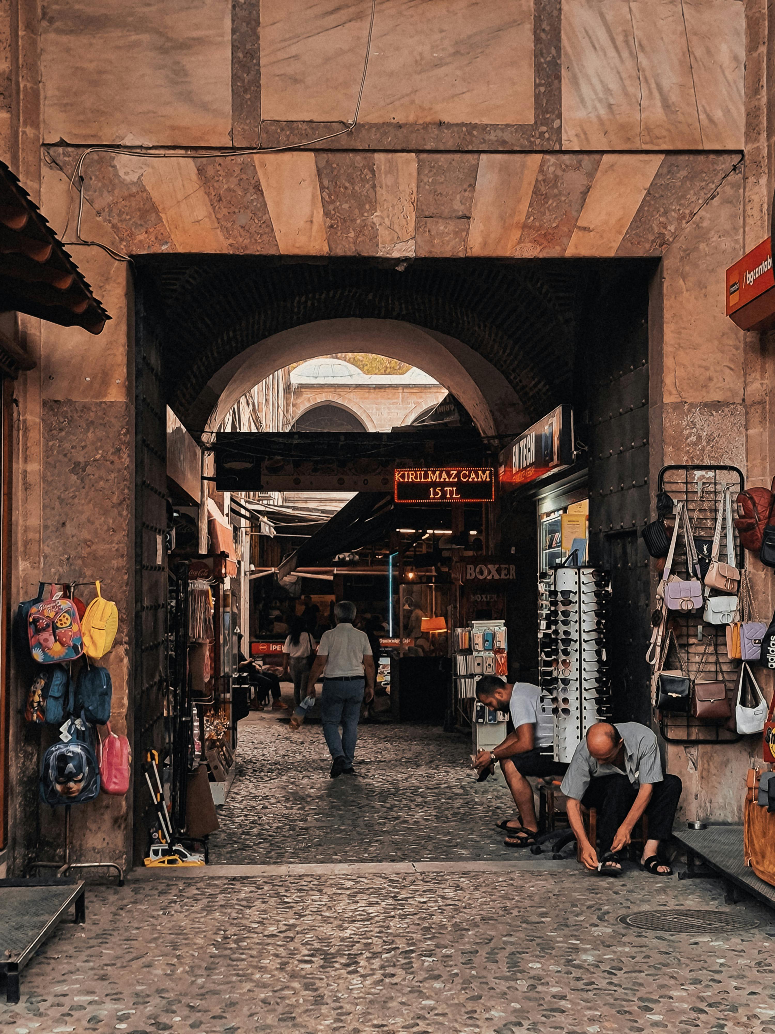 Vendors on a Cobblestone Street · Free Stock Photo