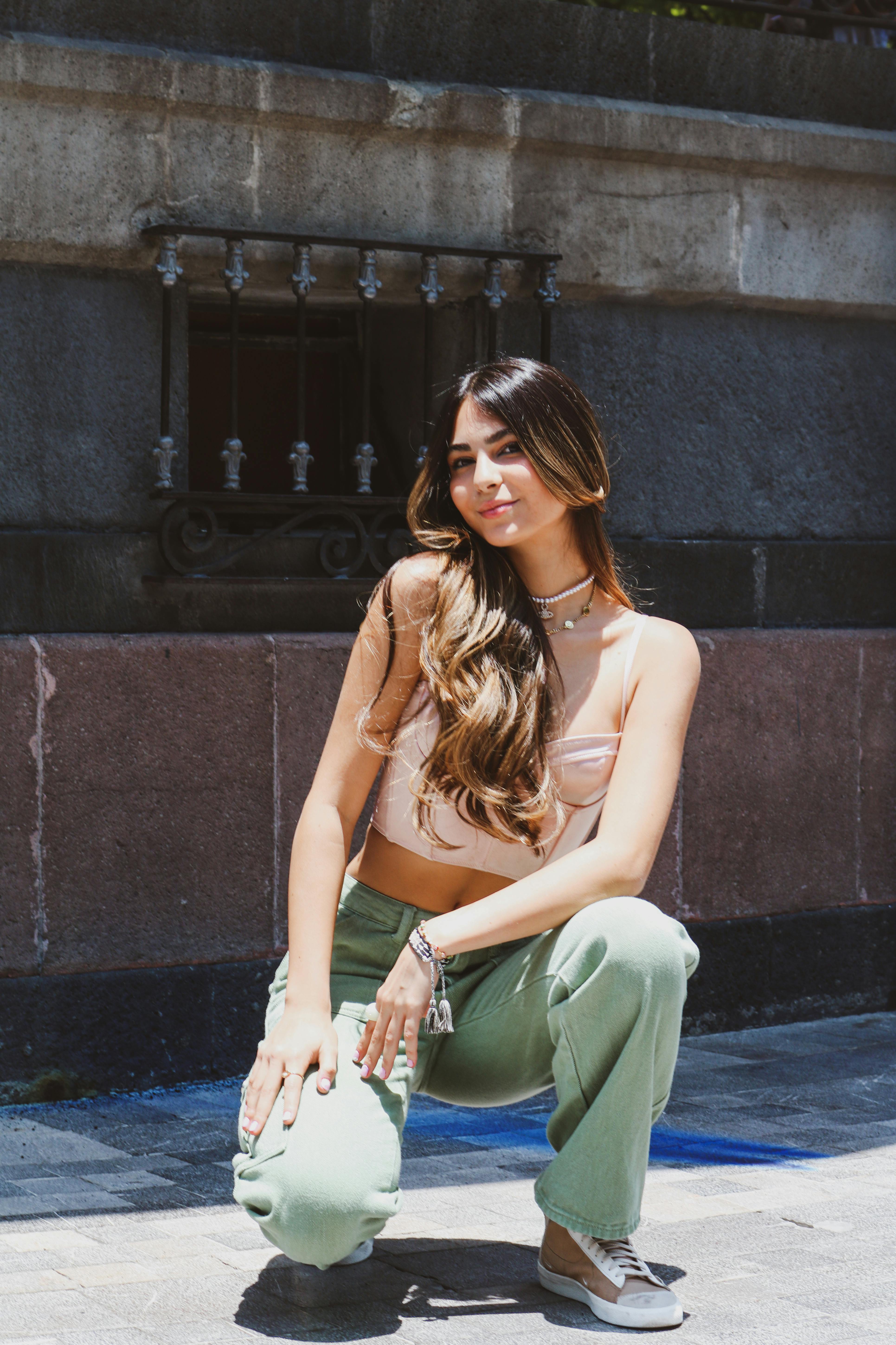 Woman with Dreadlocks with Wings Crouching in Botanical Garden · Free ...