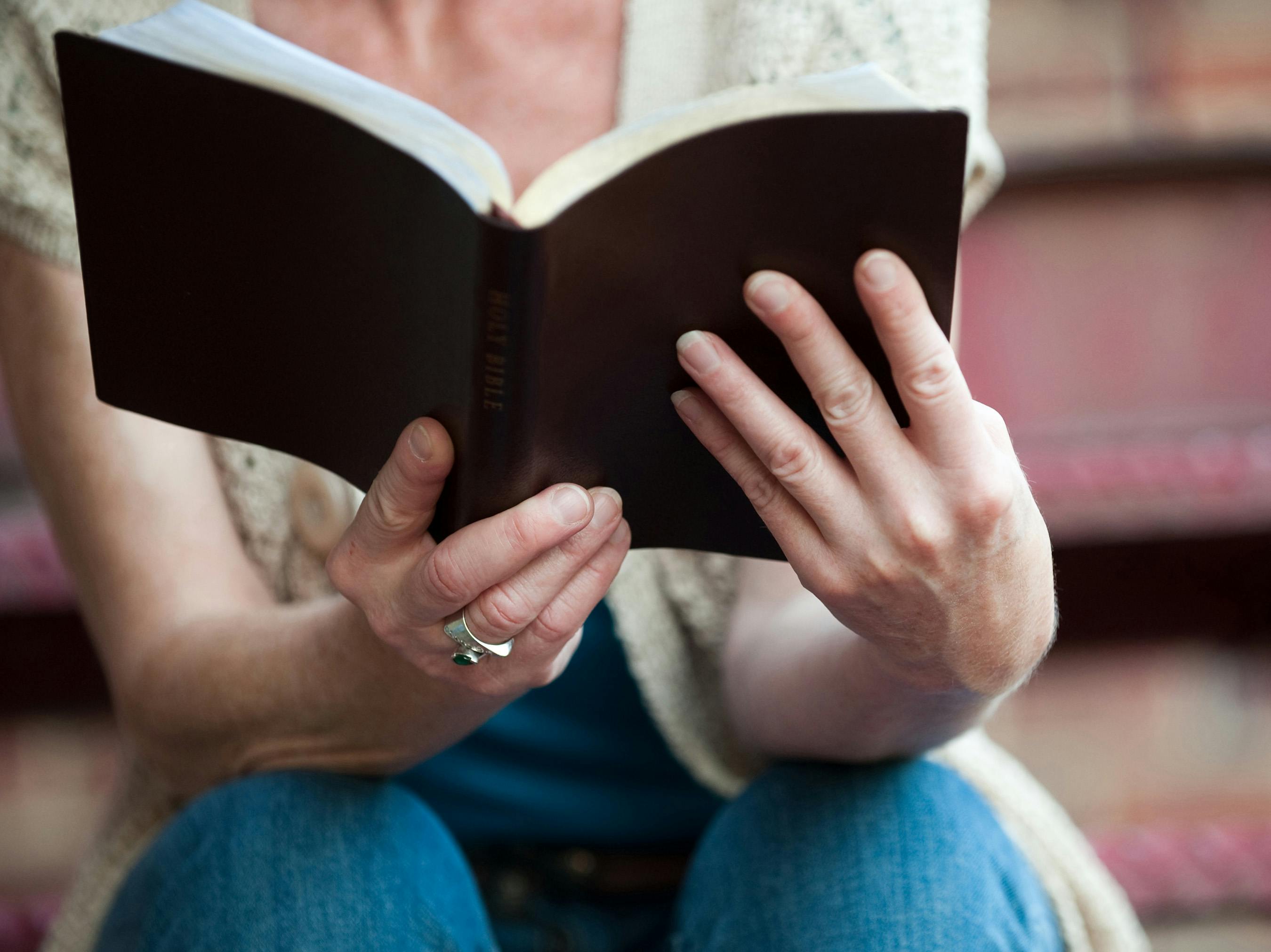 Close-Up Shot of a Person Reading a Bible · Free Stock Photo