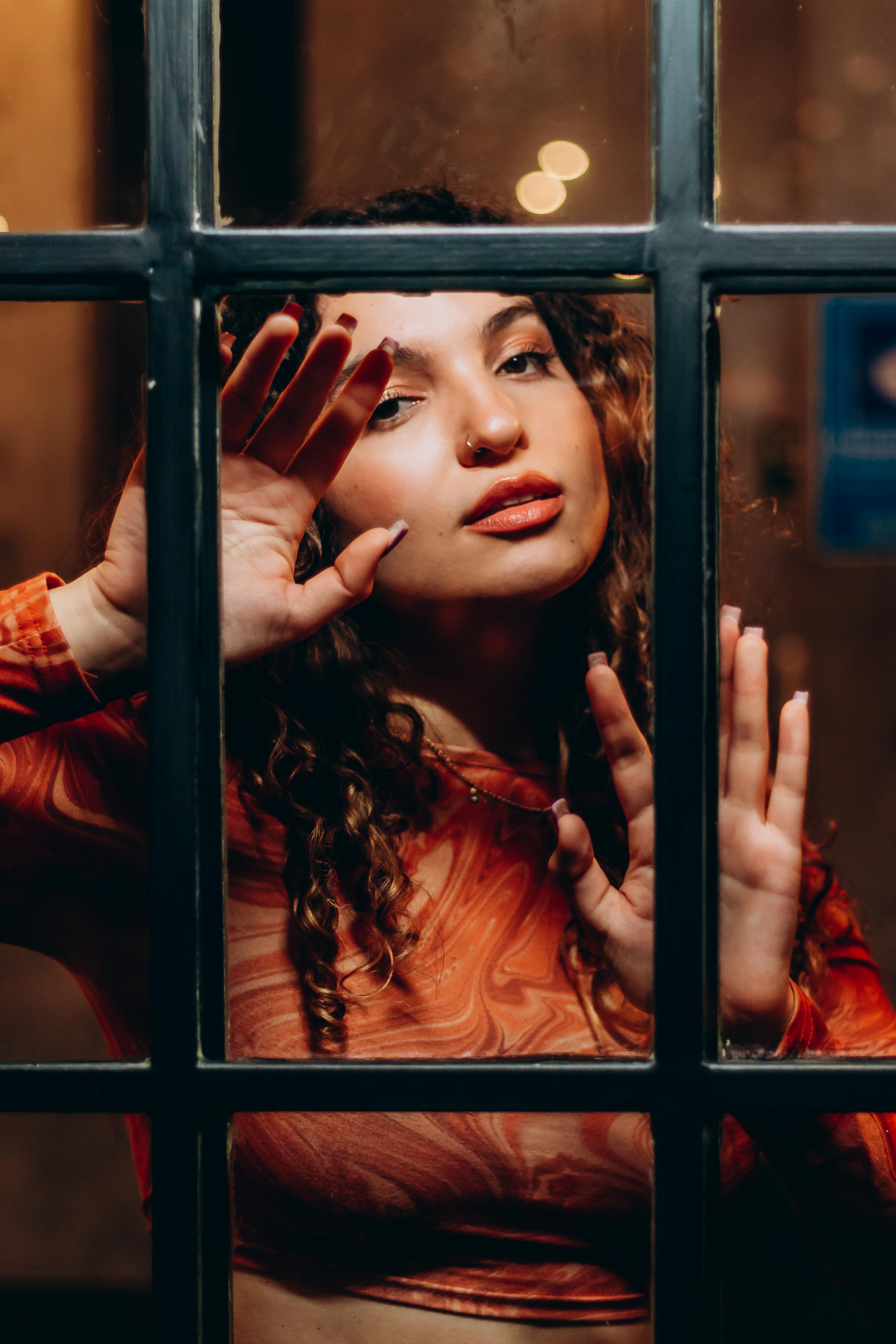 Portrait of a Woman Illuminated by a Red Light Behind Glass · Free ...