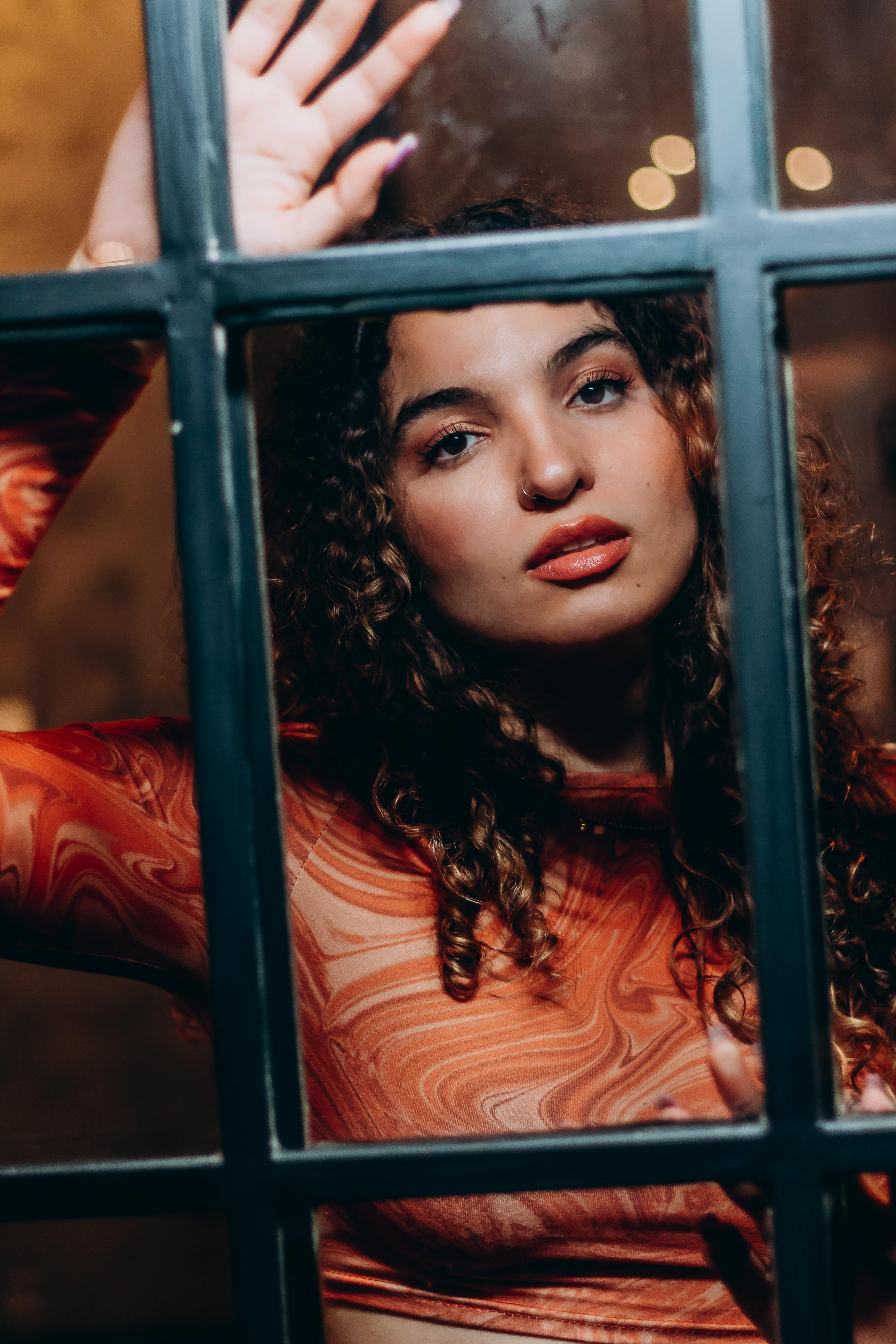 Portrait of a Woman Illuminated by a Red Light Behind Glass · Free ...